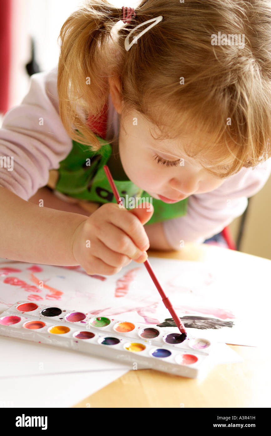 Young child painting Stock Photo - Alamy