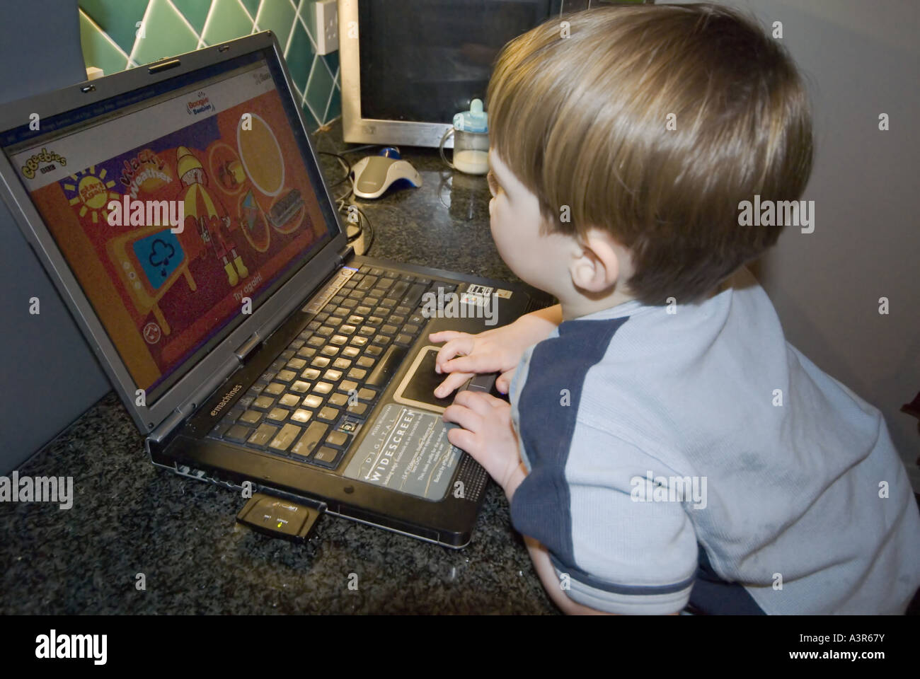 Child using a laptop Stock Photo - Alamy