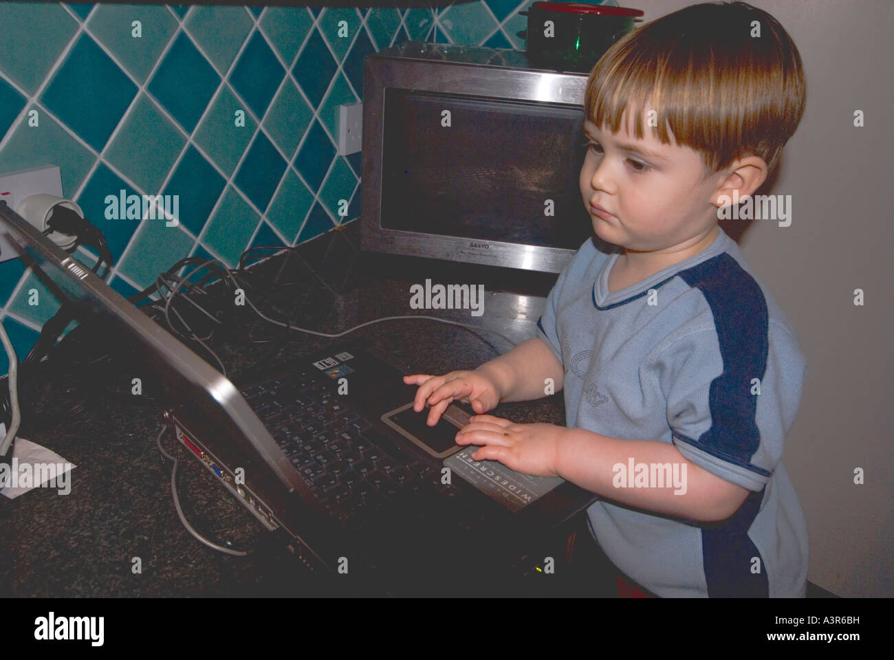 Child using a laptop Stock Photo - Alamy