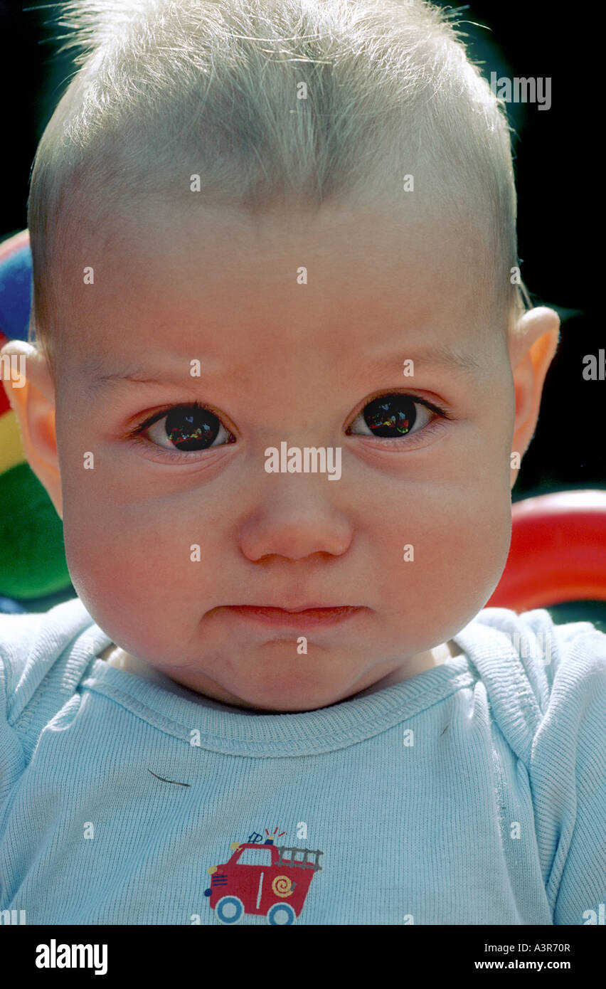 Baby boy standing in activity center Stock Photo - Alamy