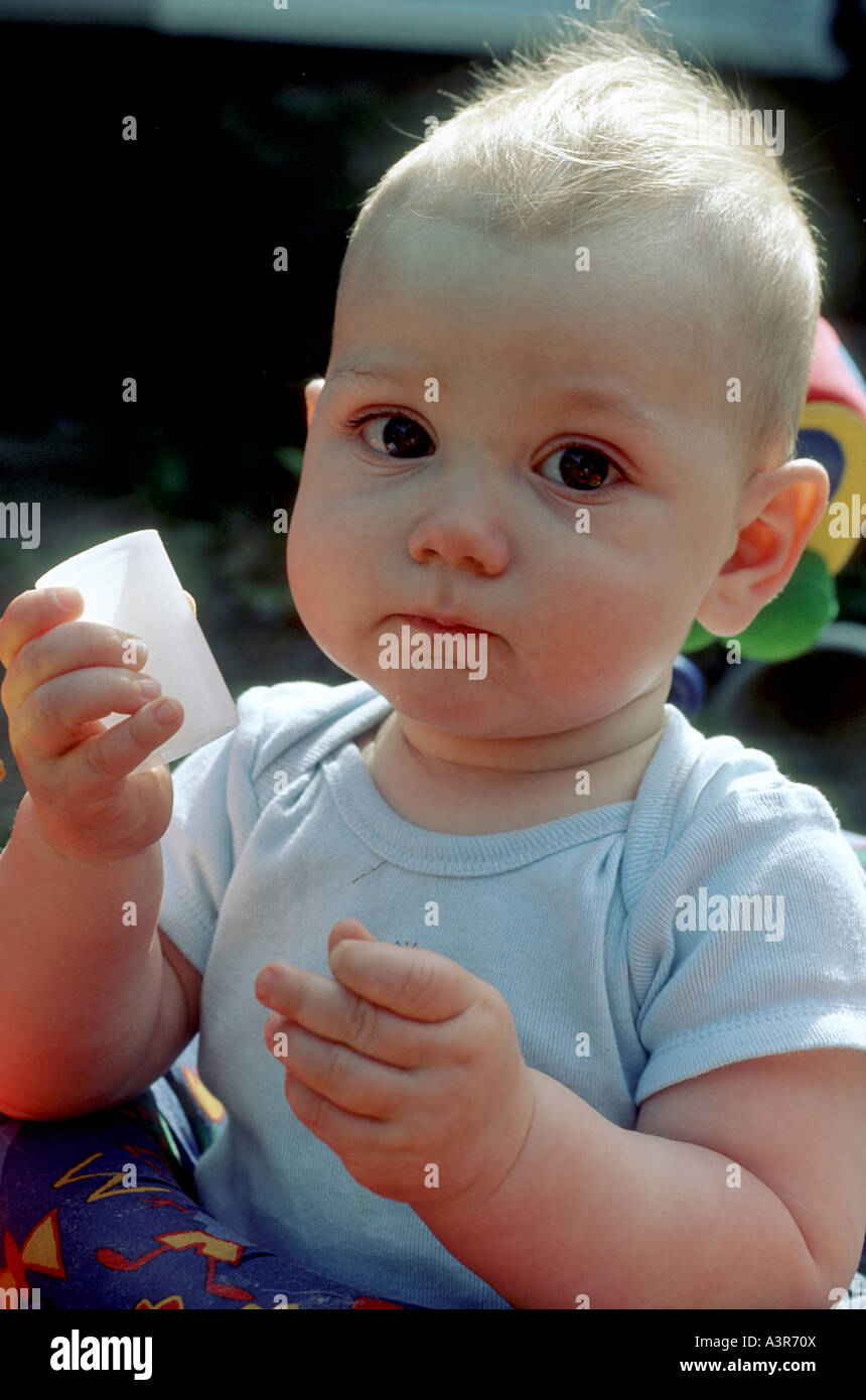 Baby standing in activity center Stock Photo - Alamy