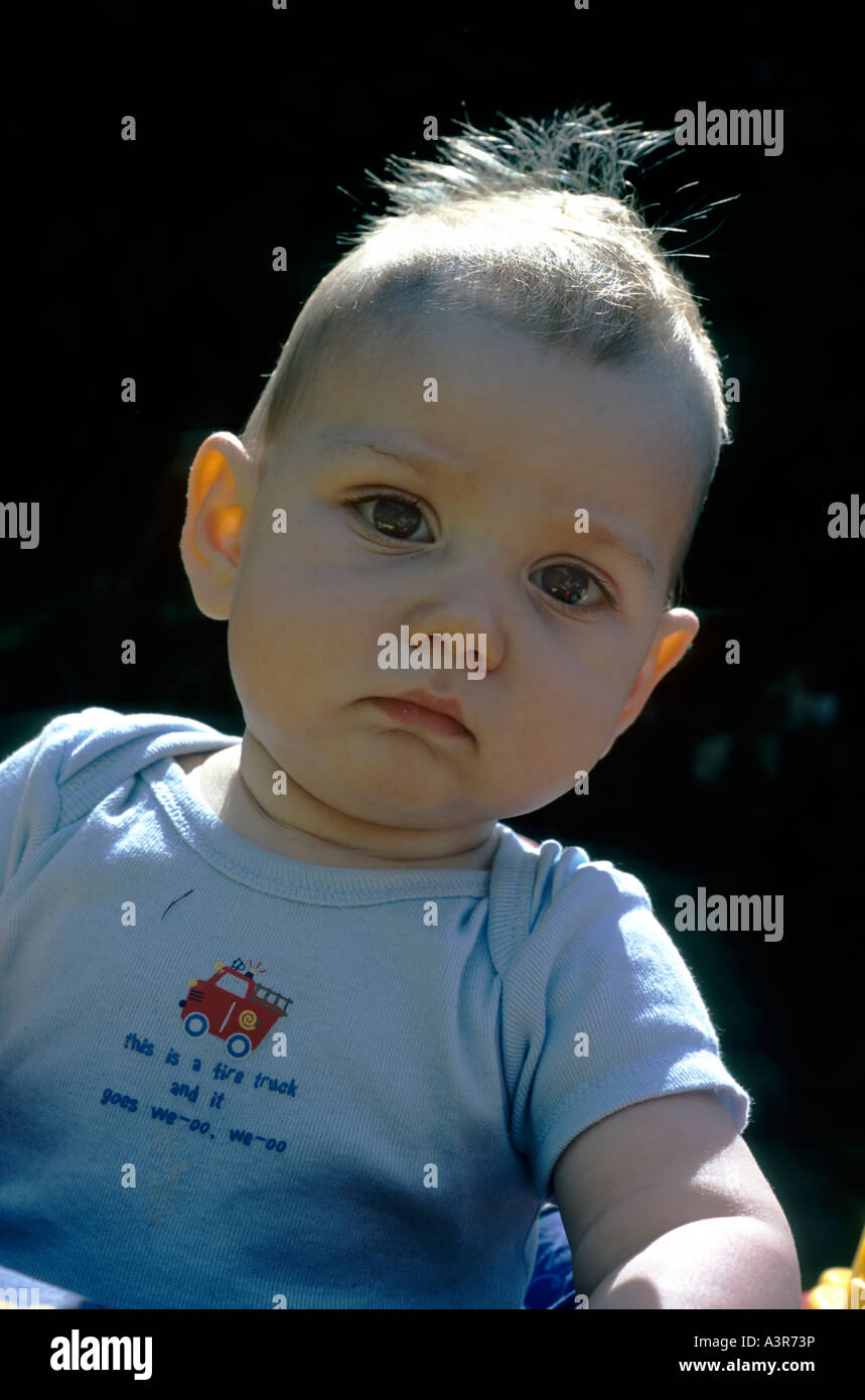 Baby boy standing in activity center Stock Photo - Alamy