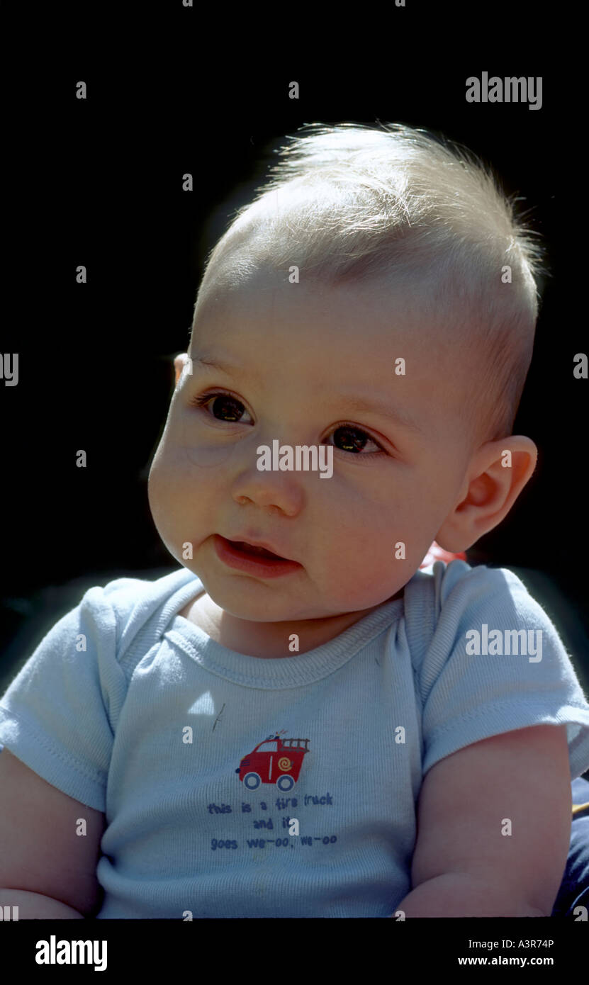 Baby boy standing in activity center Stock Photo - Alamy