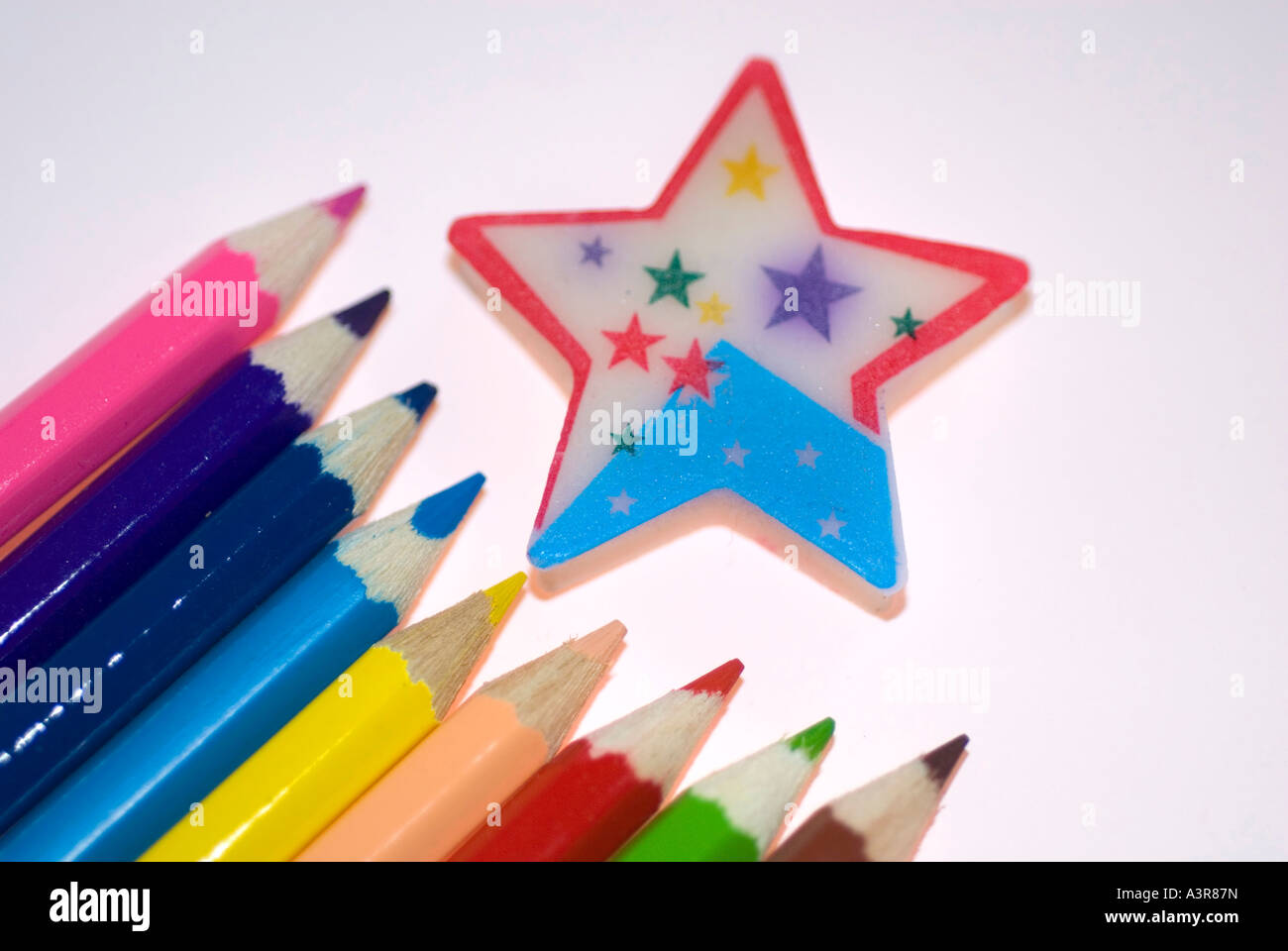 star rubber and a series of coloured pencils Stock Photo - Alamy