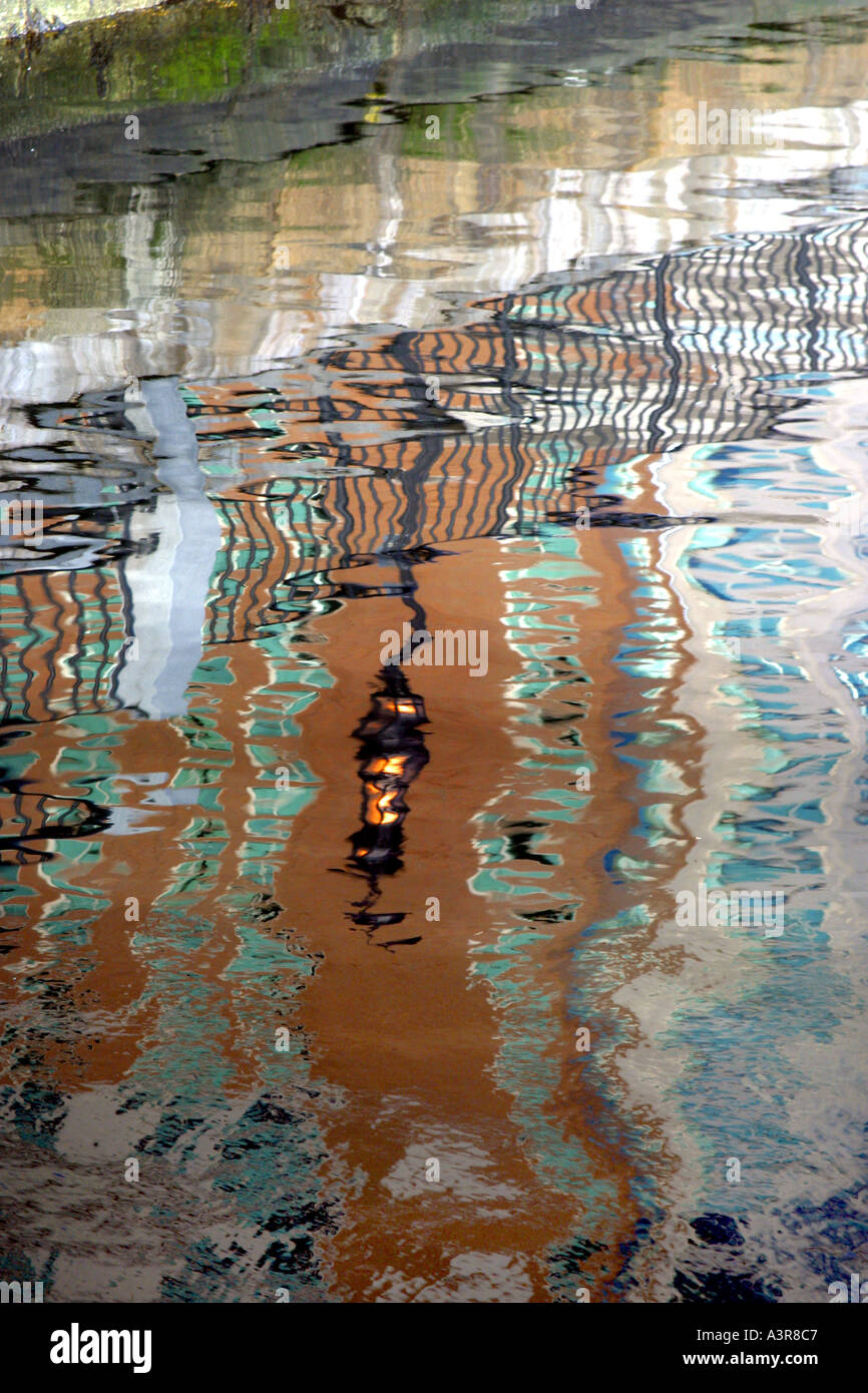 Reflection of lamp post and buildings in Boston Harbor Massachusetts ...