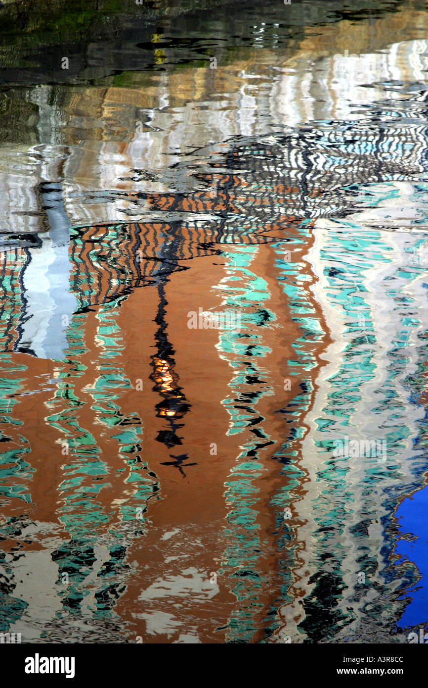 Reflection of lamp post and buildings in Boston Harbor Massachusetts ...