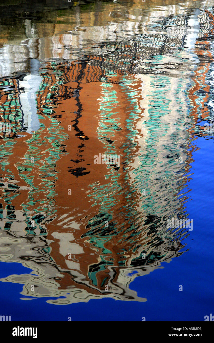 Reflection of lamp post and buildings in Boston Harbor Massachusetts ...