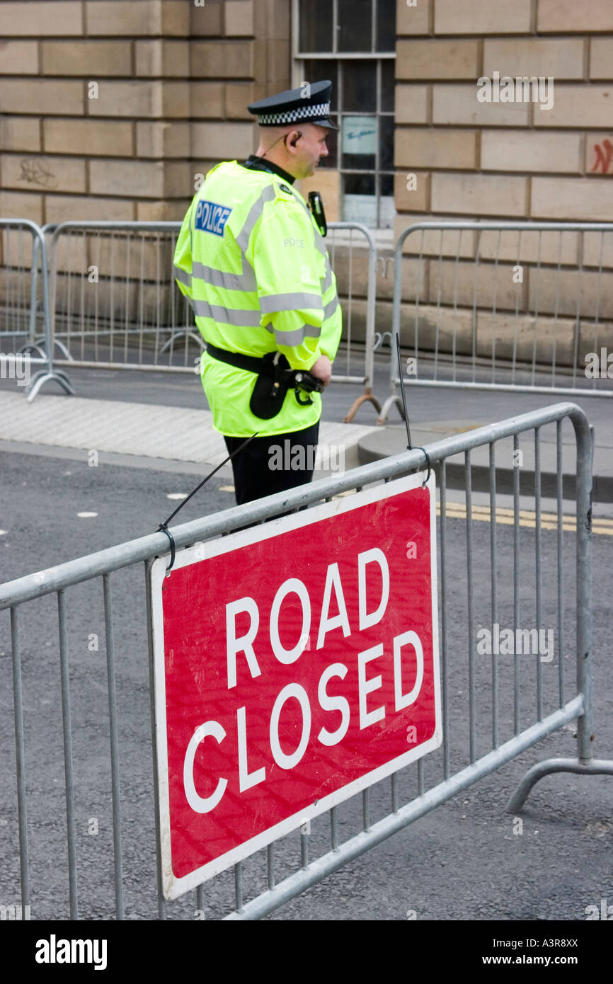 Policeman standing by a 'Road Closed' sign on the Royal Mile, Edinburgh ...