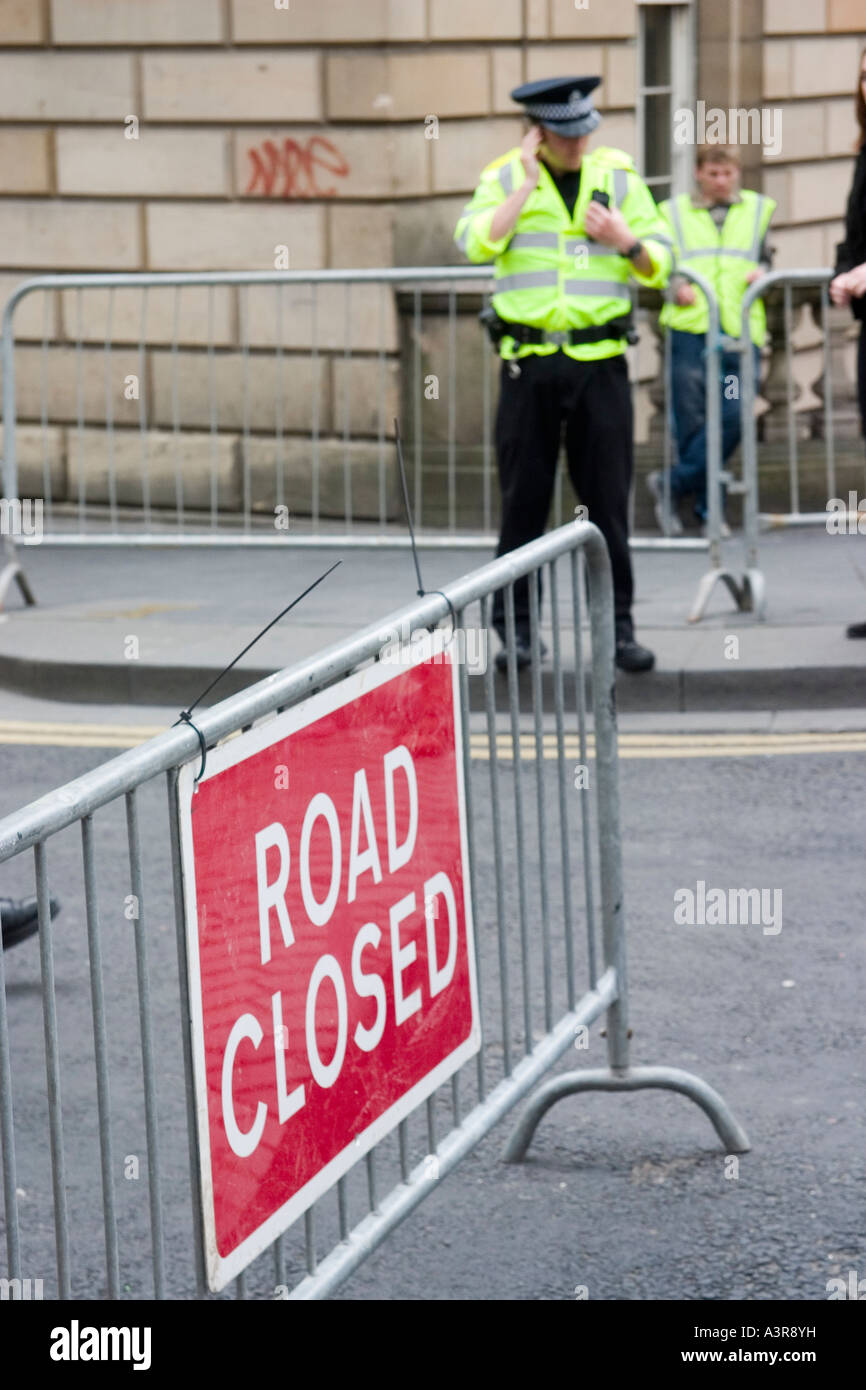 Policeman standing by a 'Road Closed' sign on the Royal Mile, Edinburgh ...