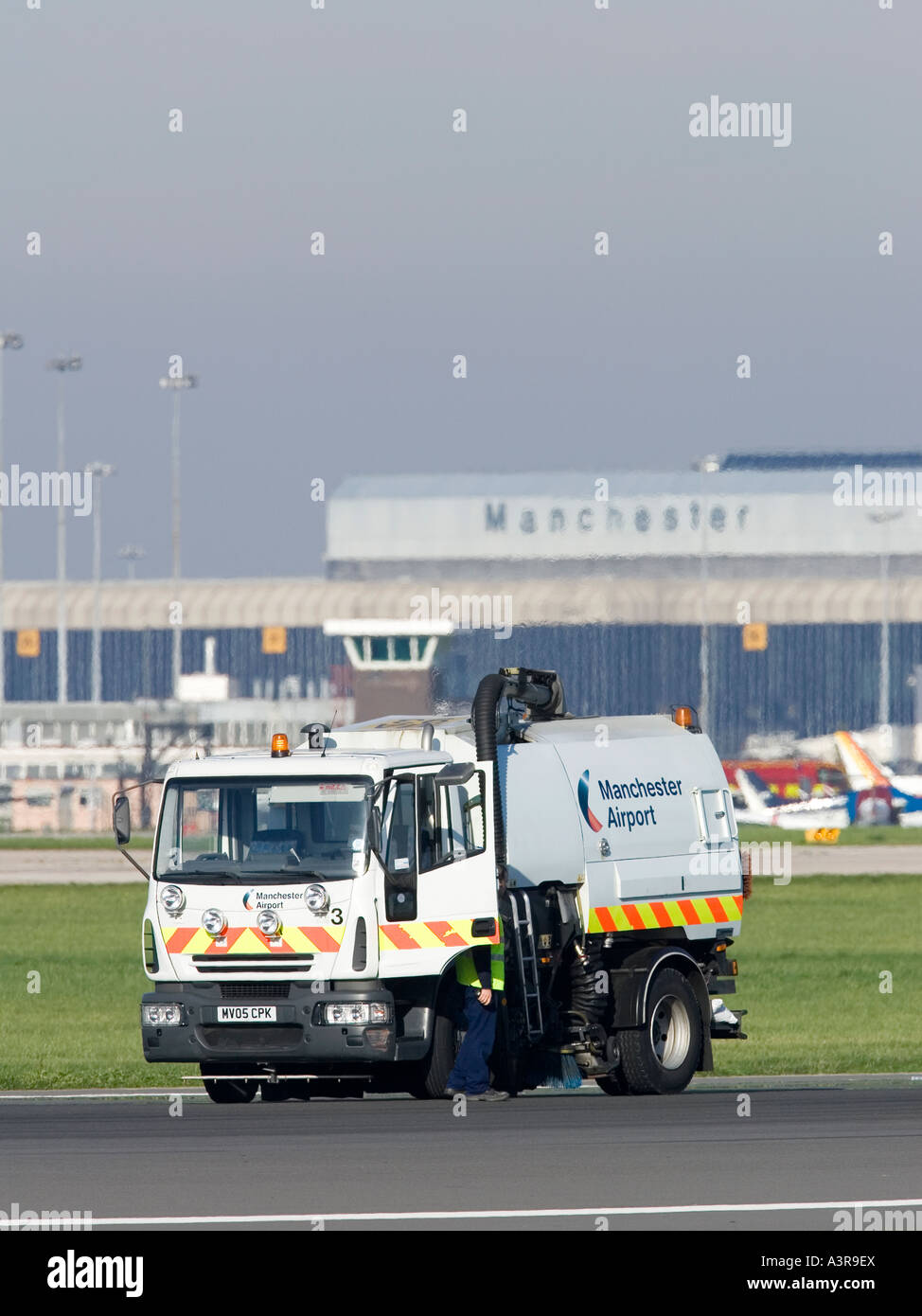 Airfield maintenance engineers on runway tarmac Stock Photo - Alamy
