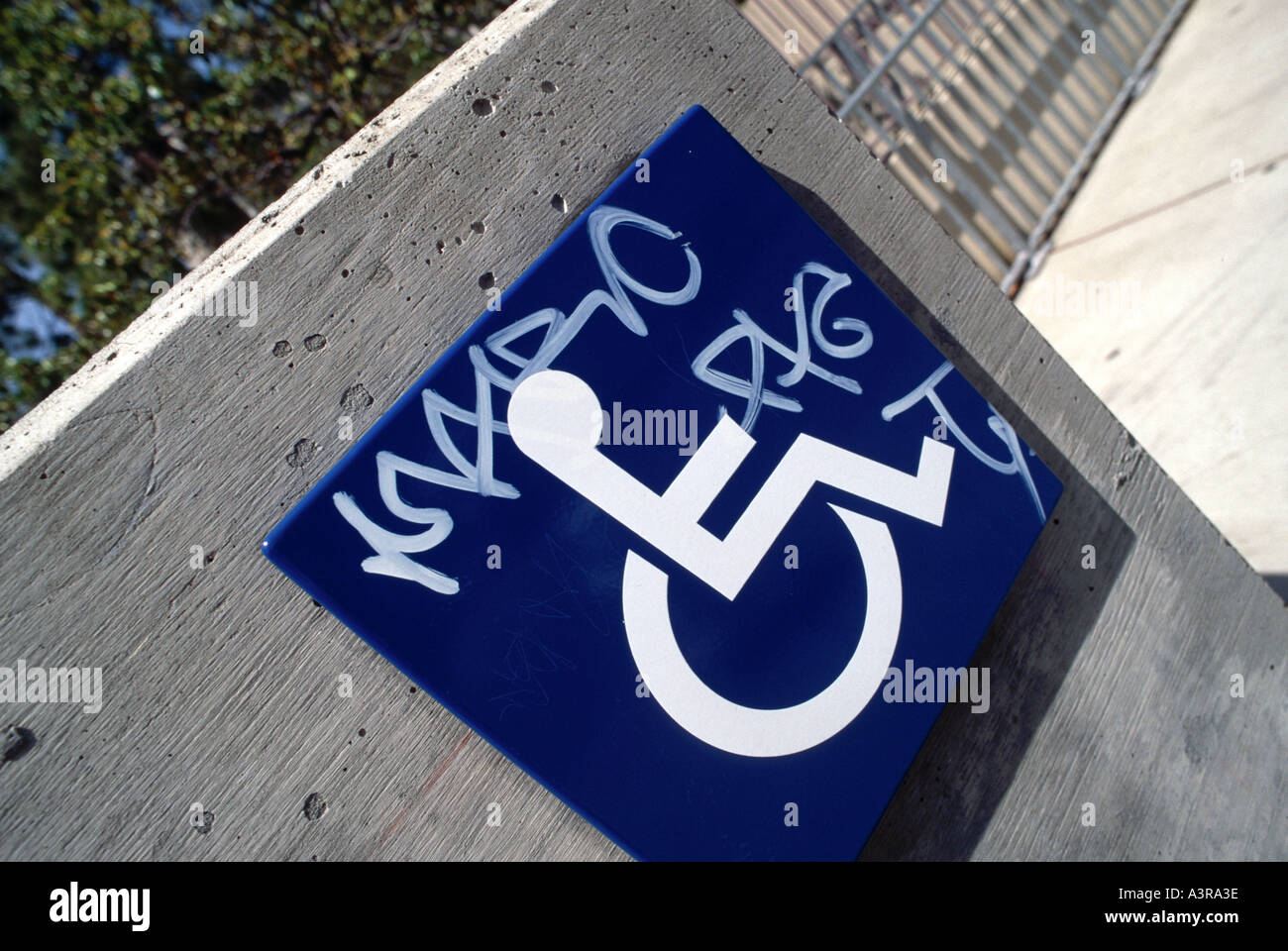 defaced and Marked up true real handicapped parking and ramp sign in ...