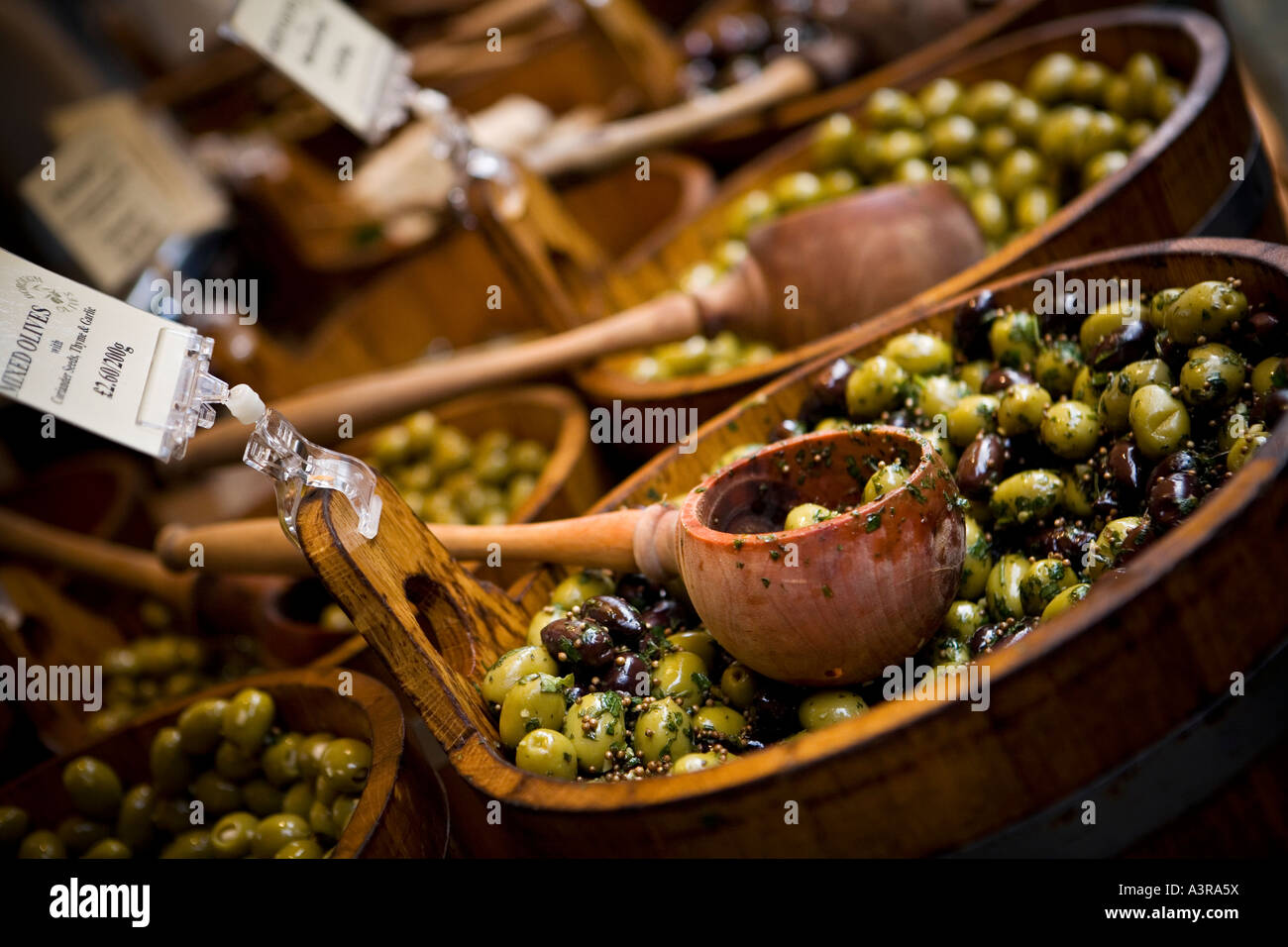 Olives in wooden barrels on an olives stall in London Borough market ...