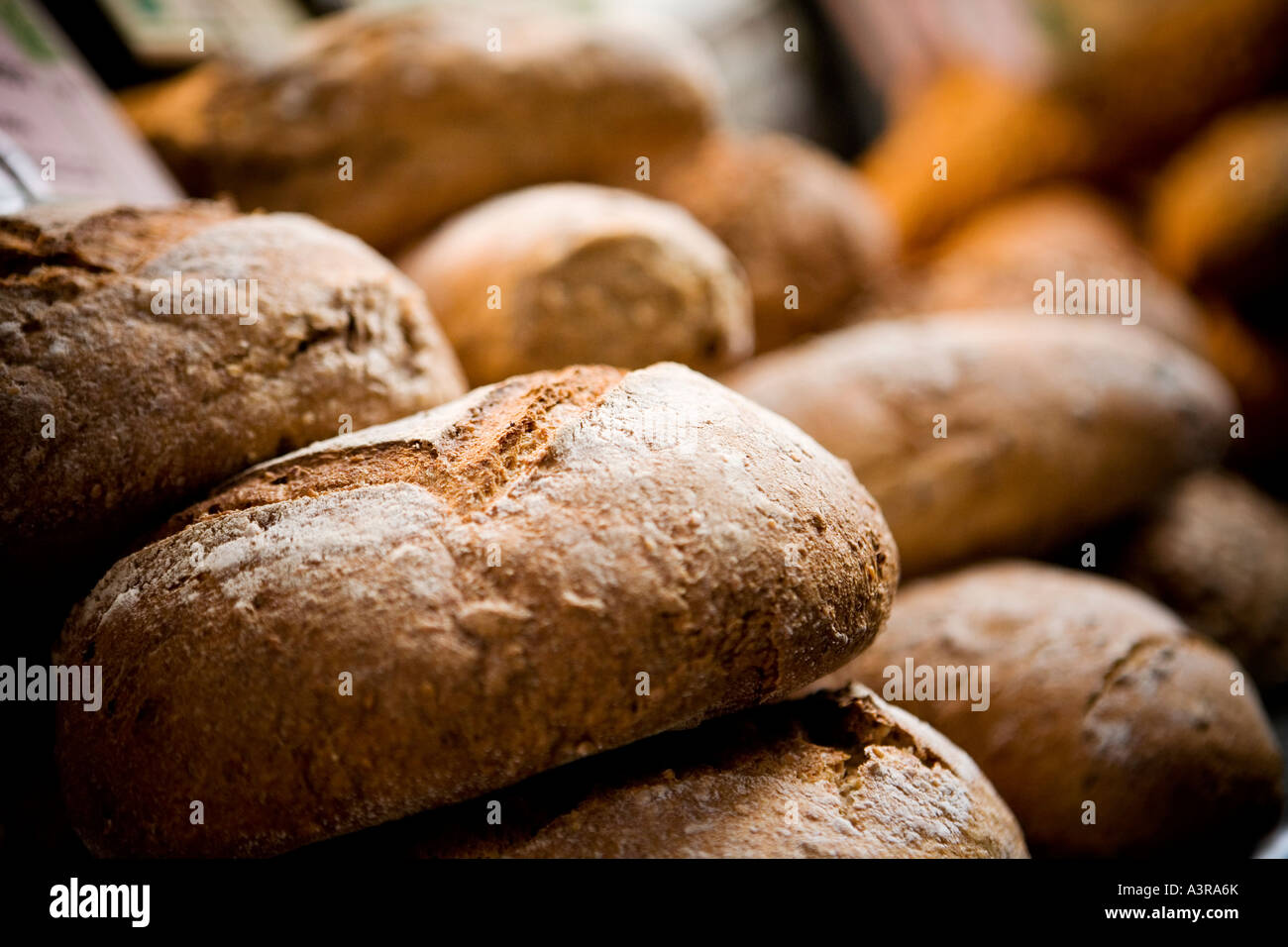 Freshly baked loaves of bread on a bread stall in London Borough market ...