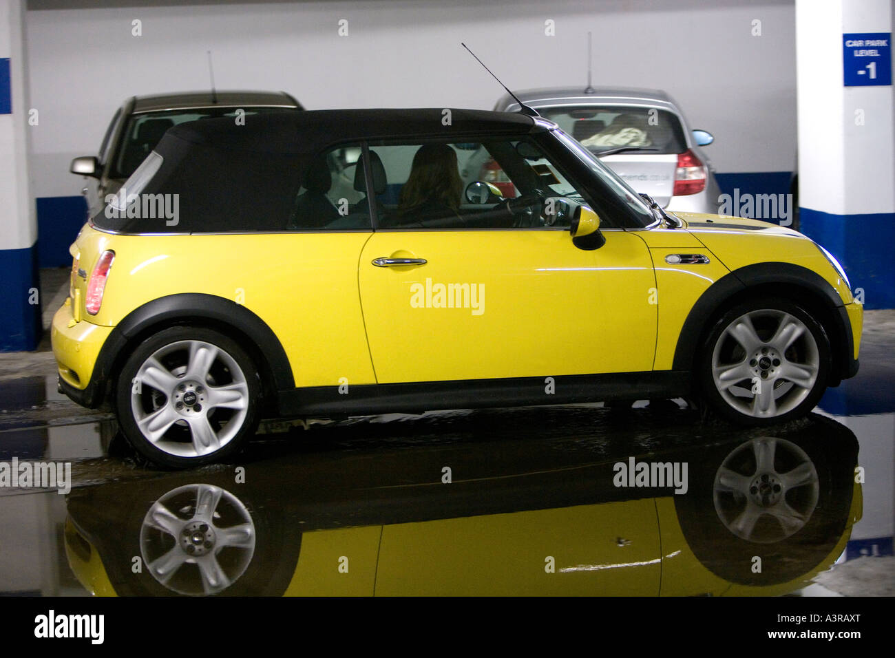 Yellow mini convertible in underground carpark Stock Photo - Alamy