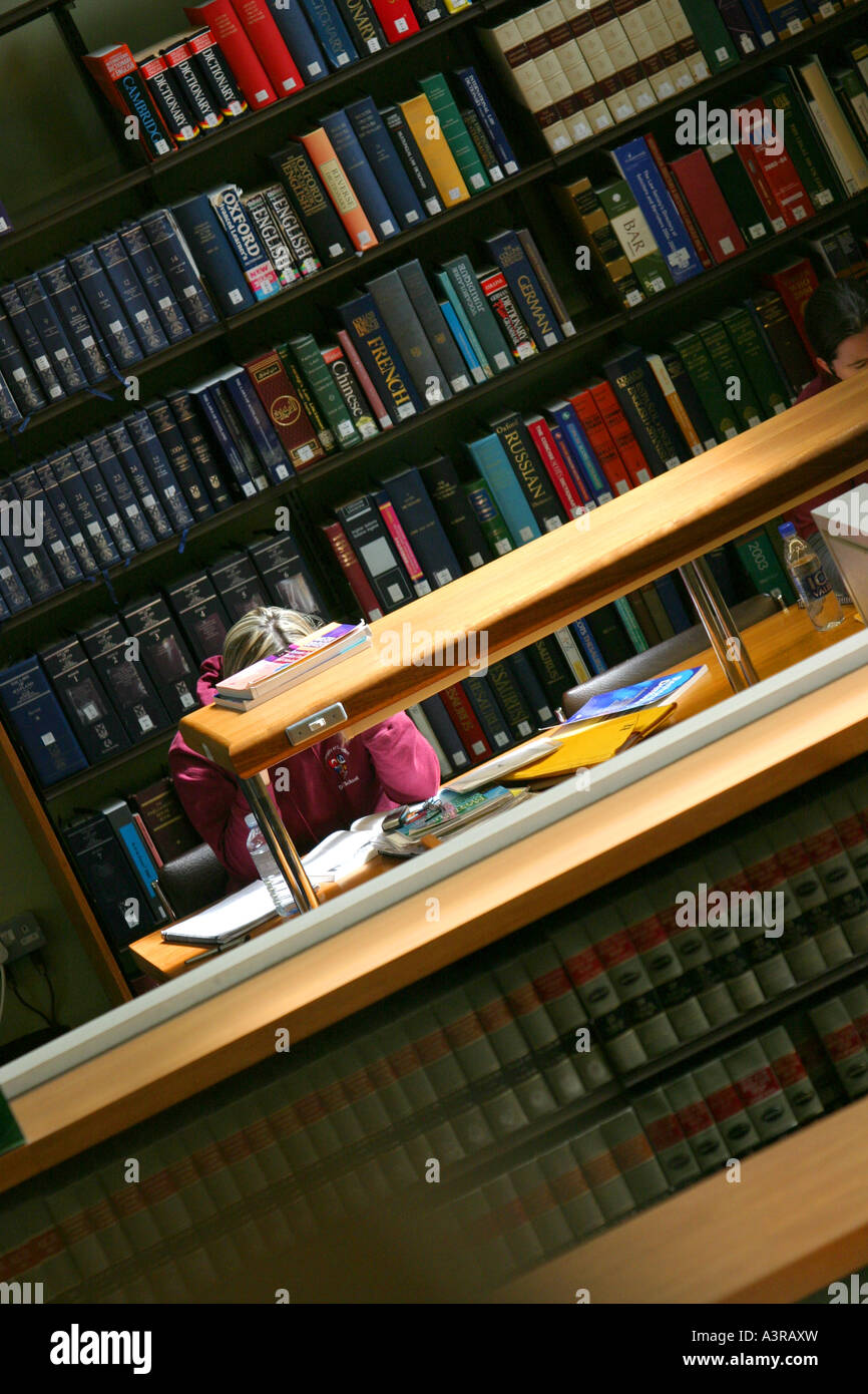 Person studying/reading in a library Stock Photo - Alamy