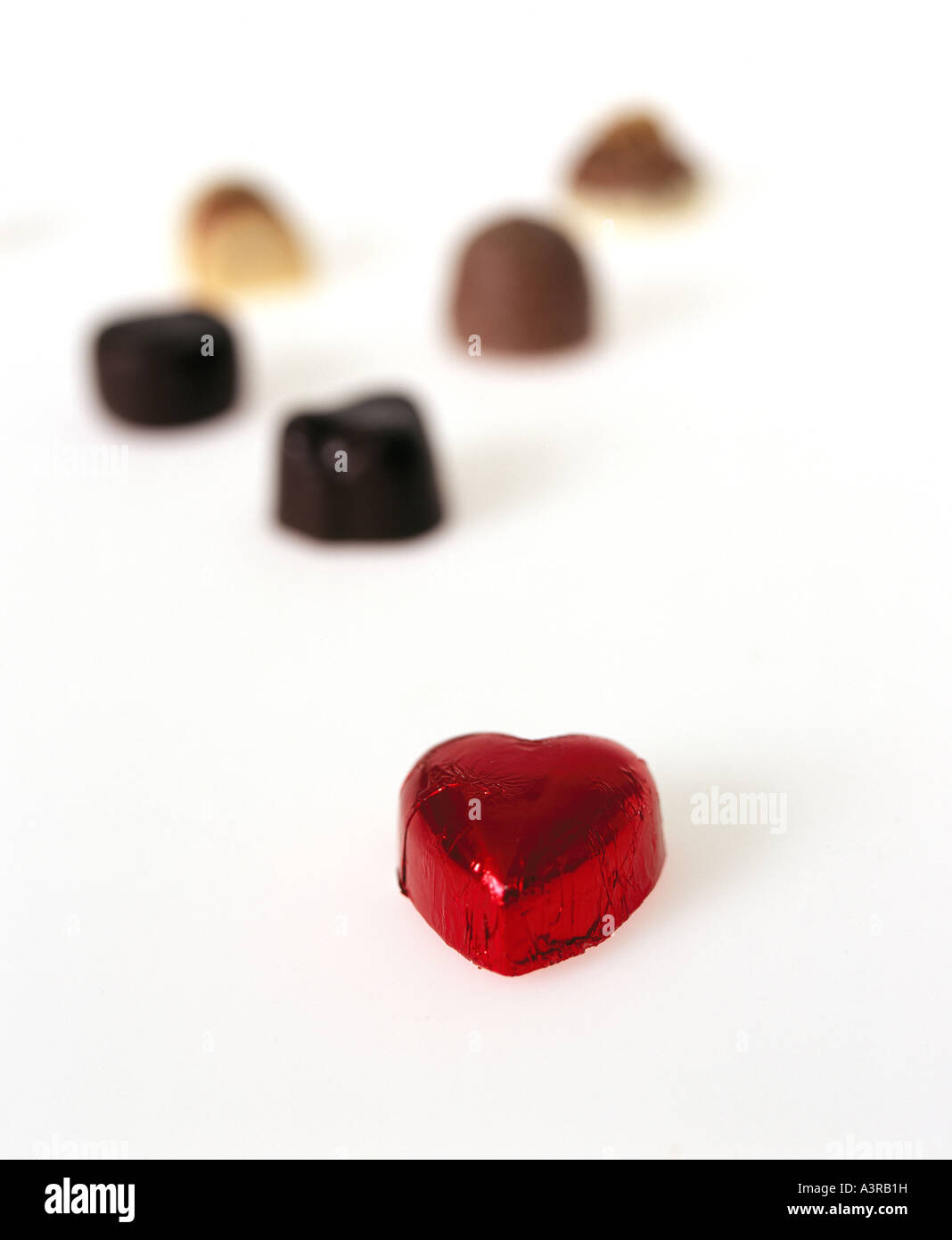 Still life of small chocolates with a heart shaped chocololate in the ...