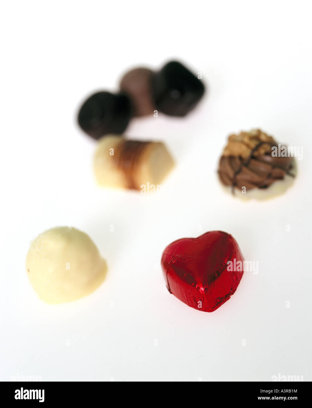 Still life of small chocolates with a heart shaped chocololate in the ...