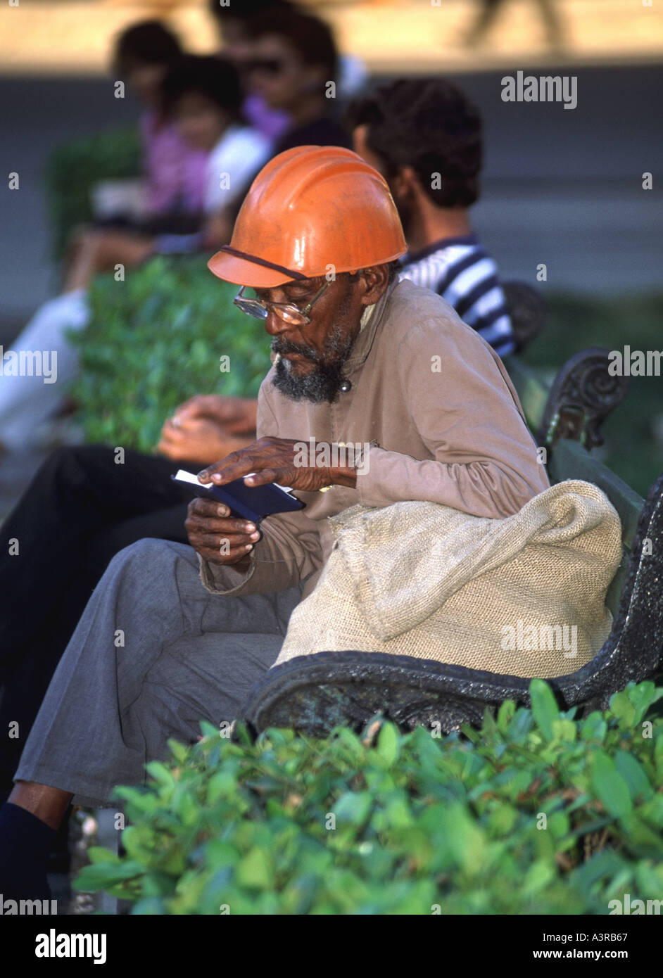 Cuban man reading his bible in park in central Havana Stock Photo - Alamy