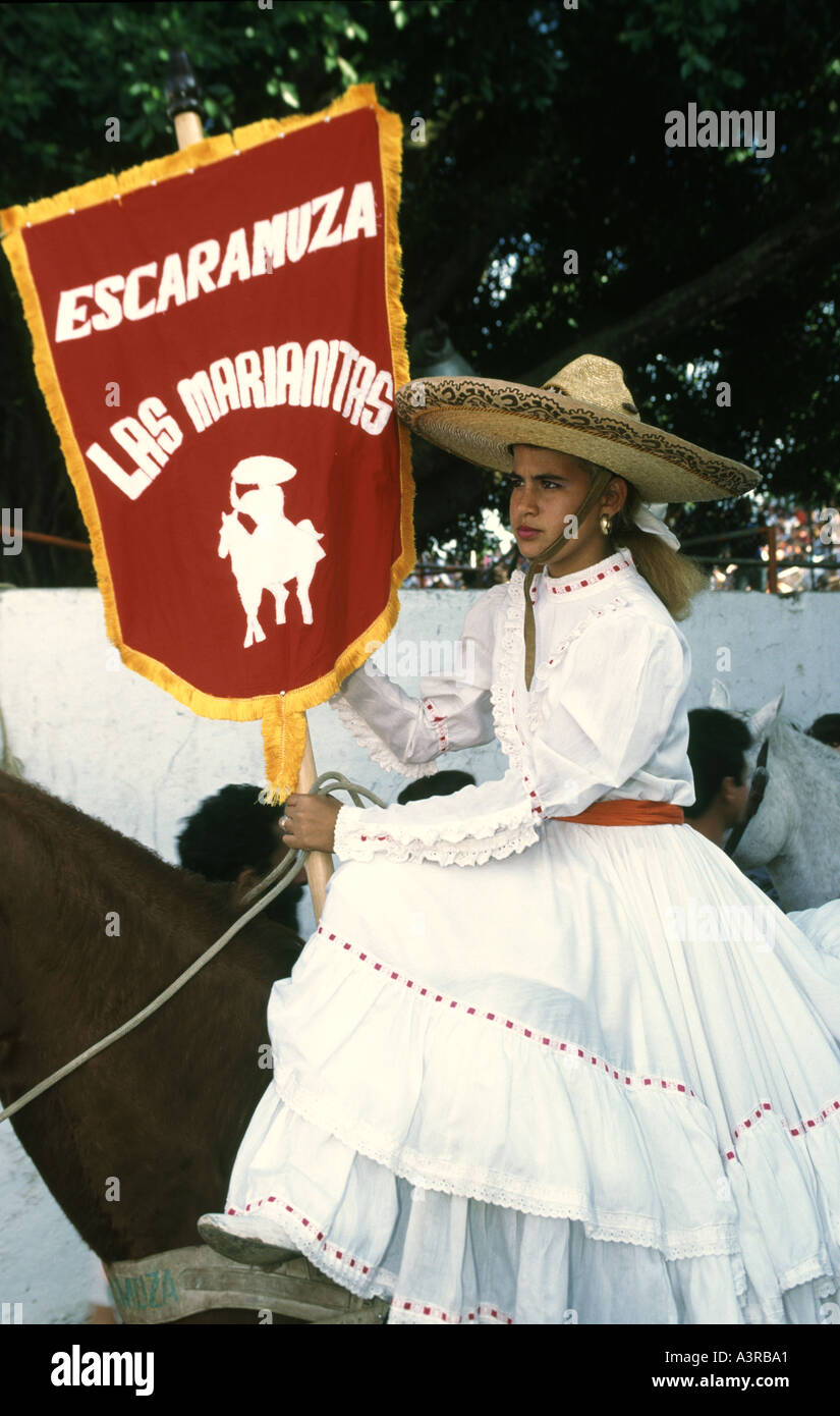 Pretty young smiling Cuban girl with sombrero and colorful banner ...