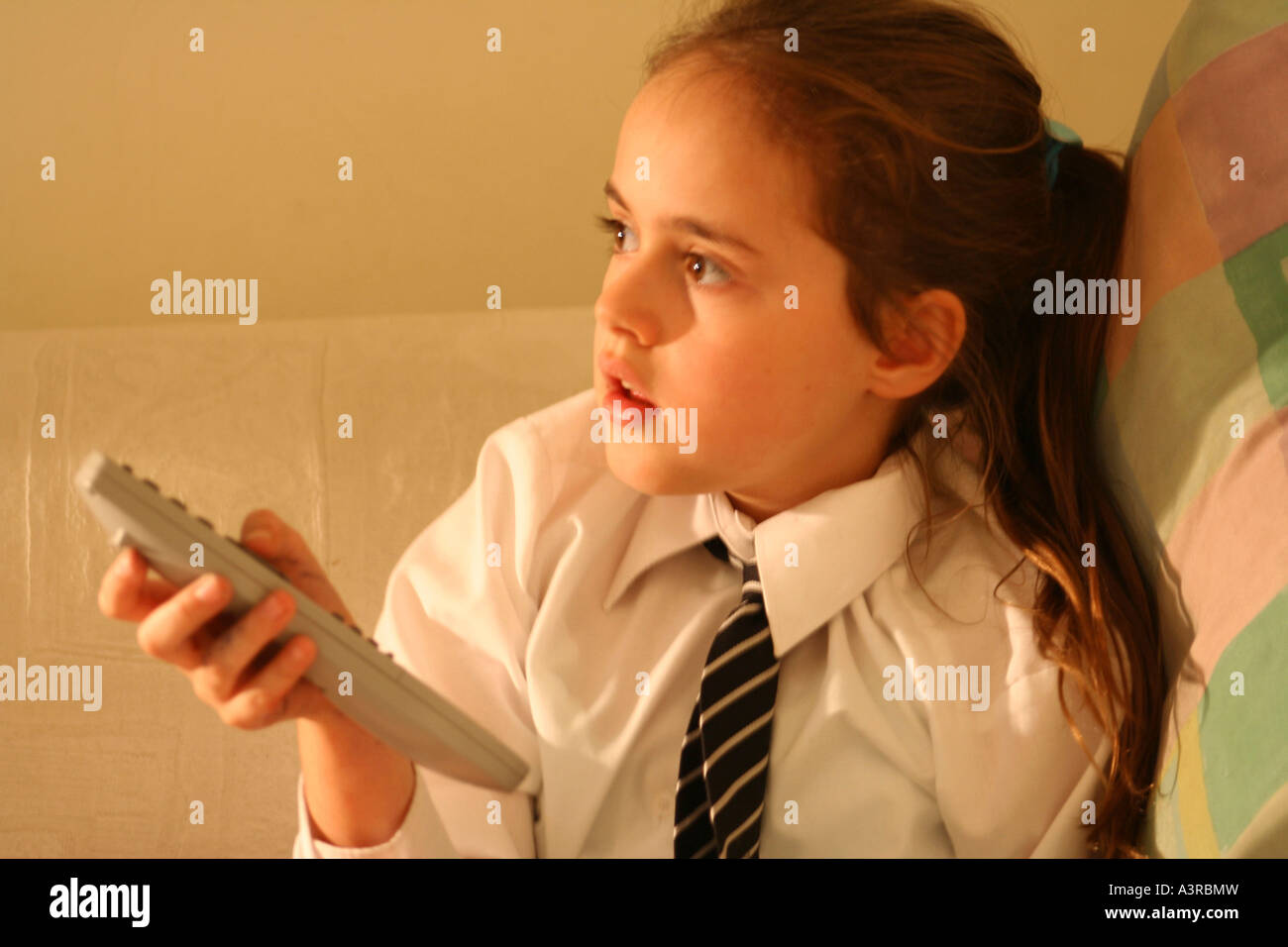 child watching TV holding a remote control Stock Photo - Alamy