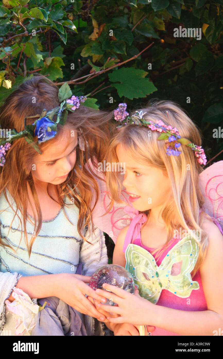 Two girls sharing secrets together Stock Photo - Alamy
