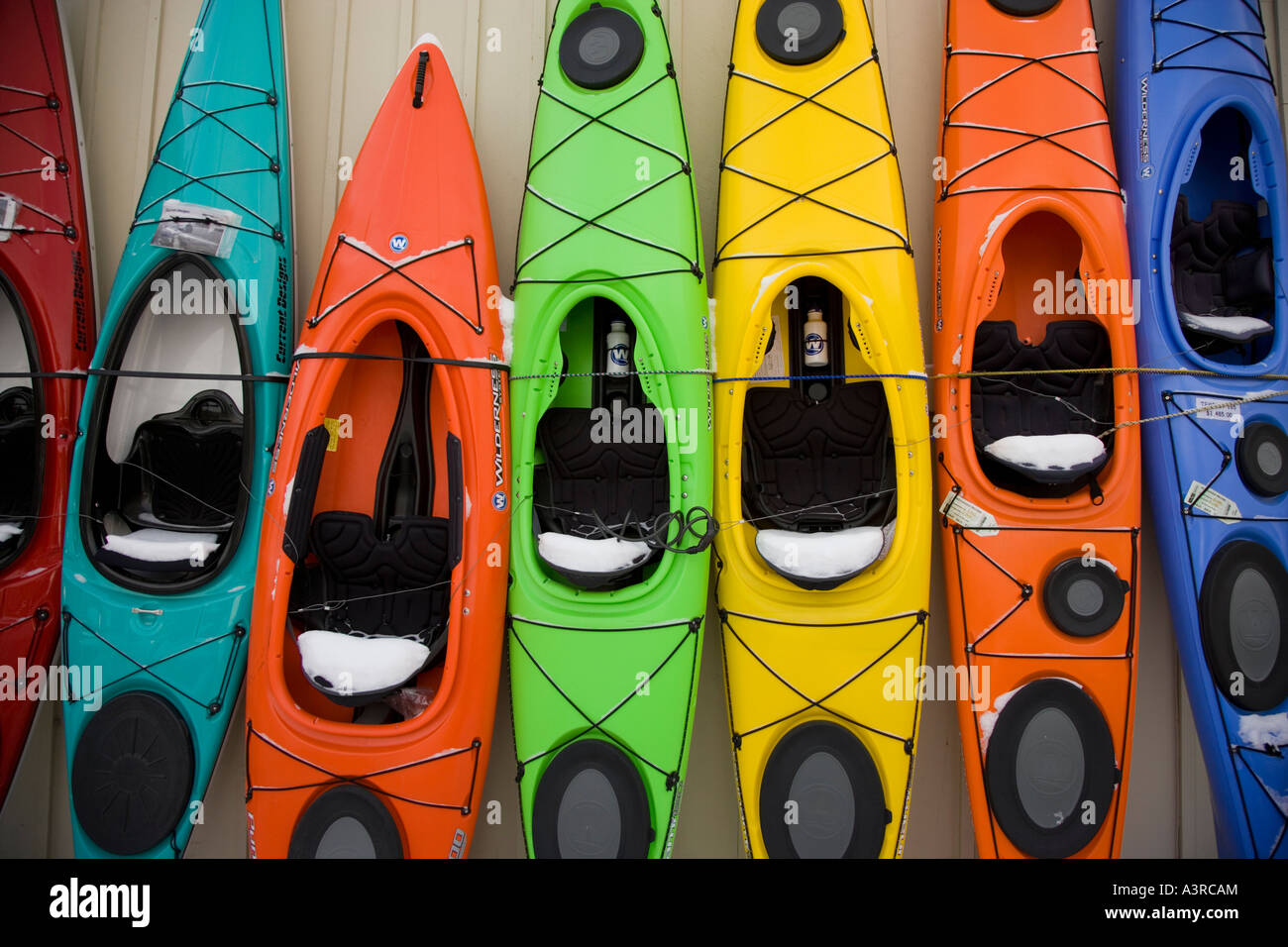 Kayaks on display against a wall Stock Photo - Alamy