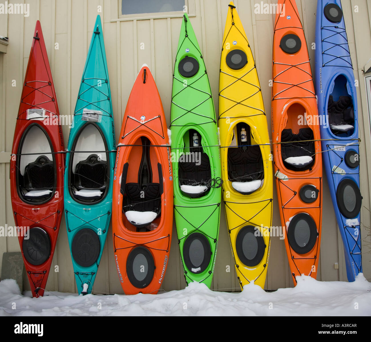 Kayaks on display against a wall Stock Photo - Alamy