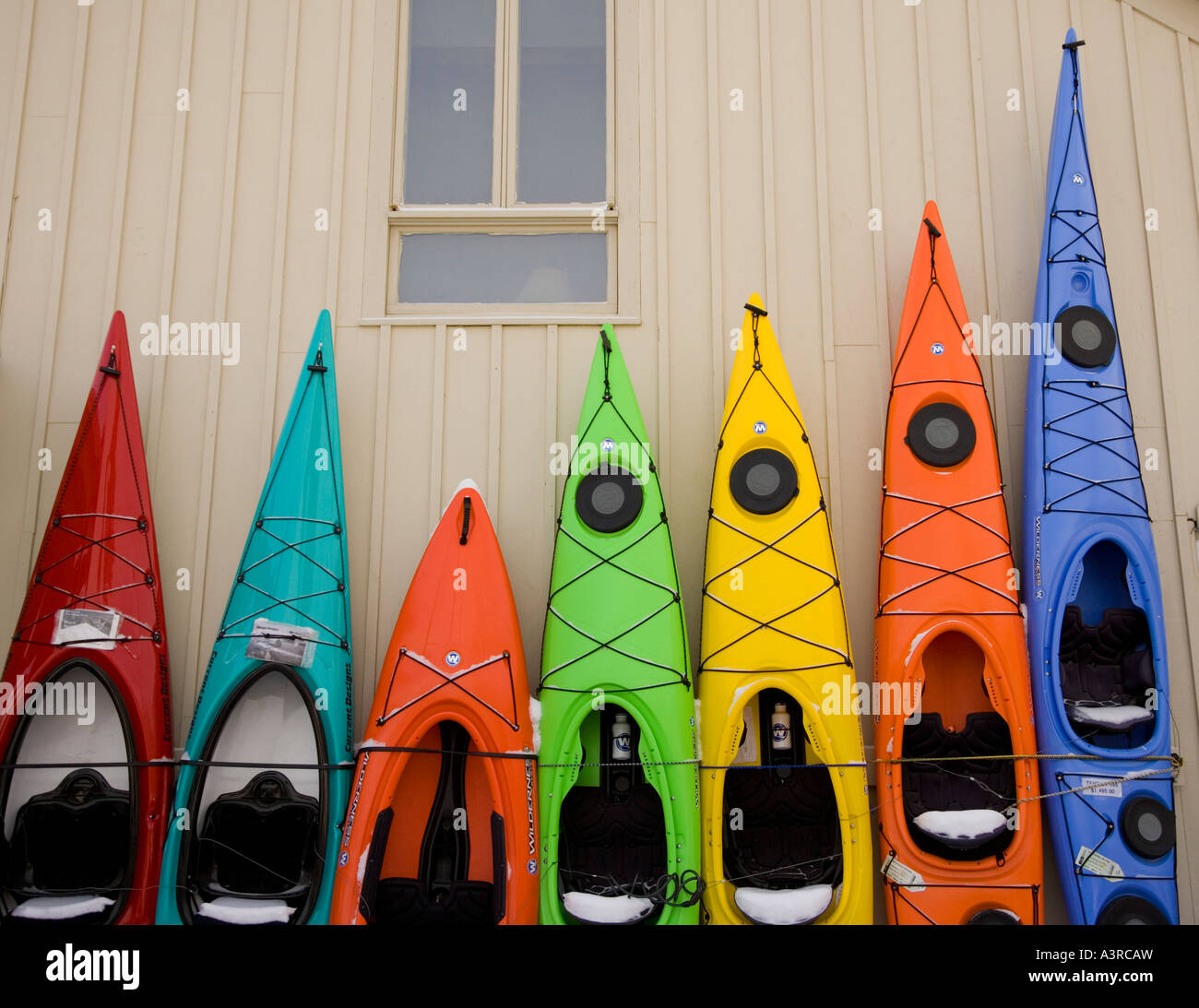 Kayaks on display against a wall Stock Photo - Alamy