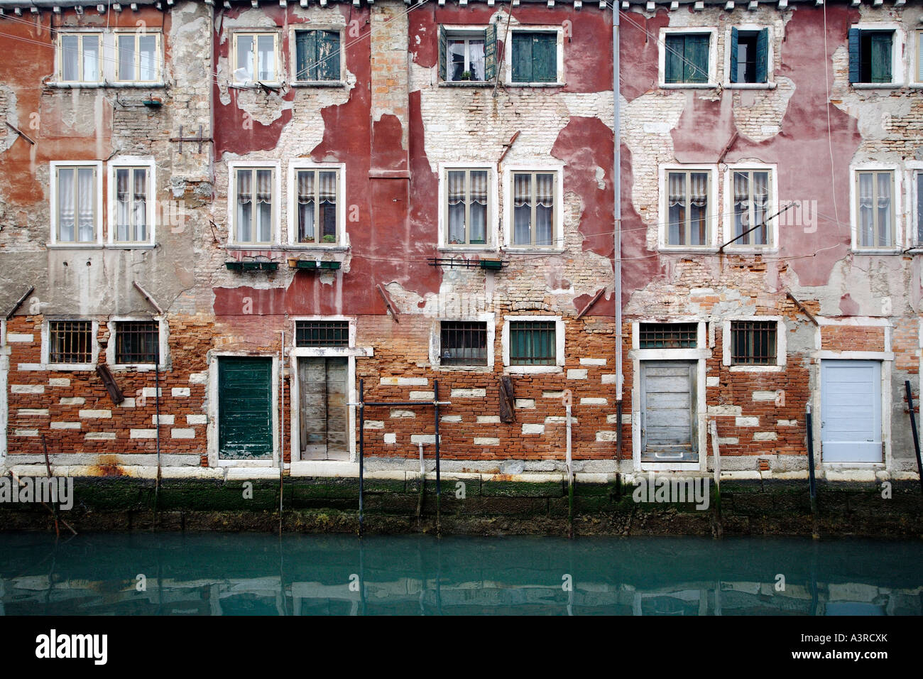Windows and crumbling plaster along side of canal, Venice, Italy Stock ...
