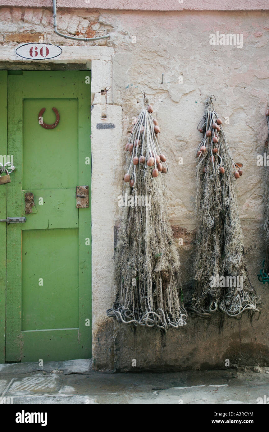 Fishing nets hanging up to dry and green door with lucky horseshoe ...