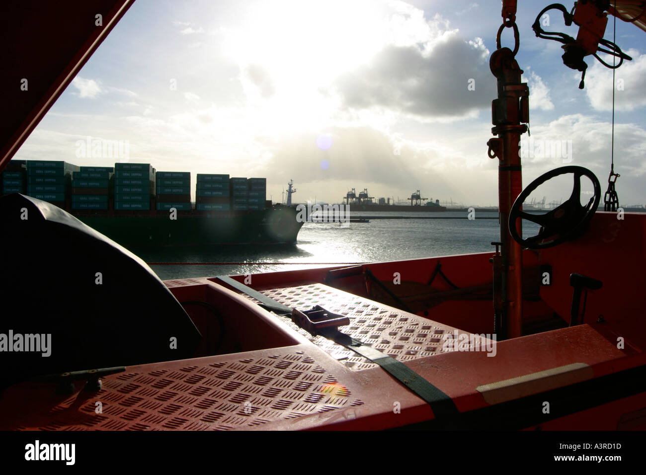 Ferry Lifeboat detail with container barge and oil rigs in distance ...
