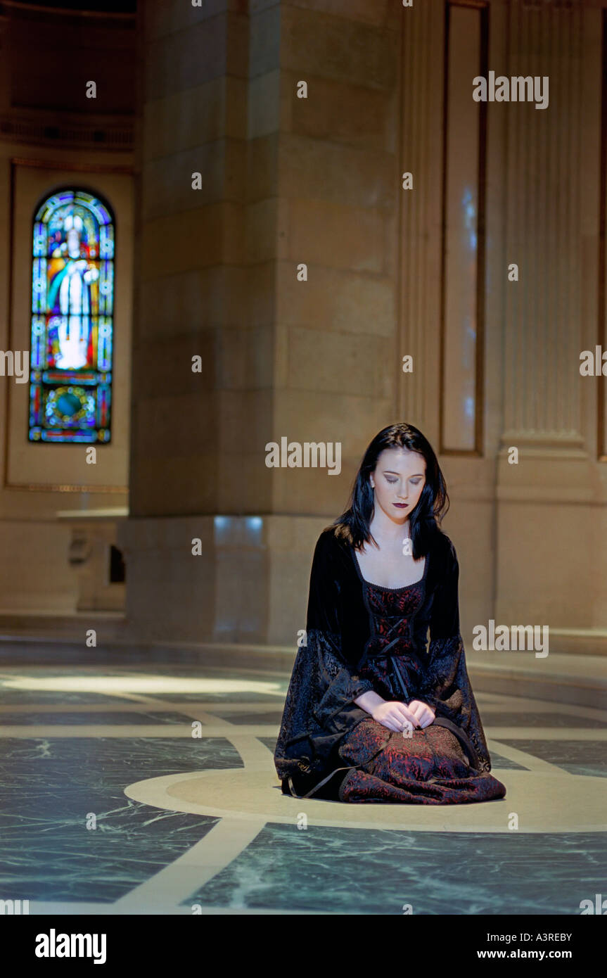 Portrait of a young Goth girl sitting in a church Stock Photo - Alamy