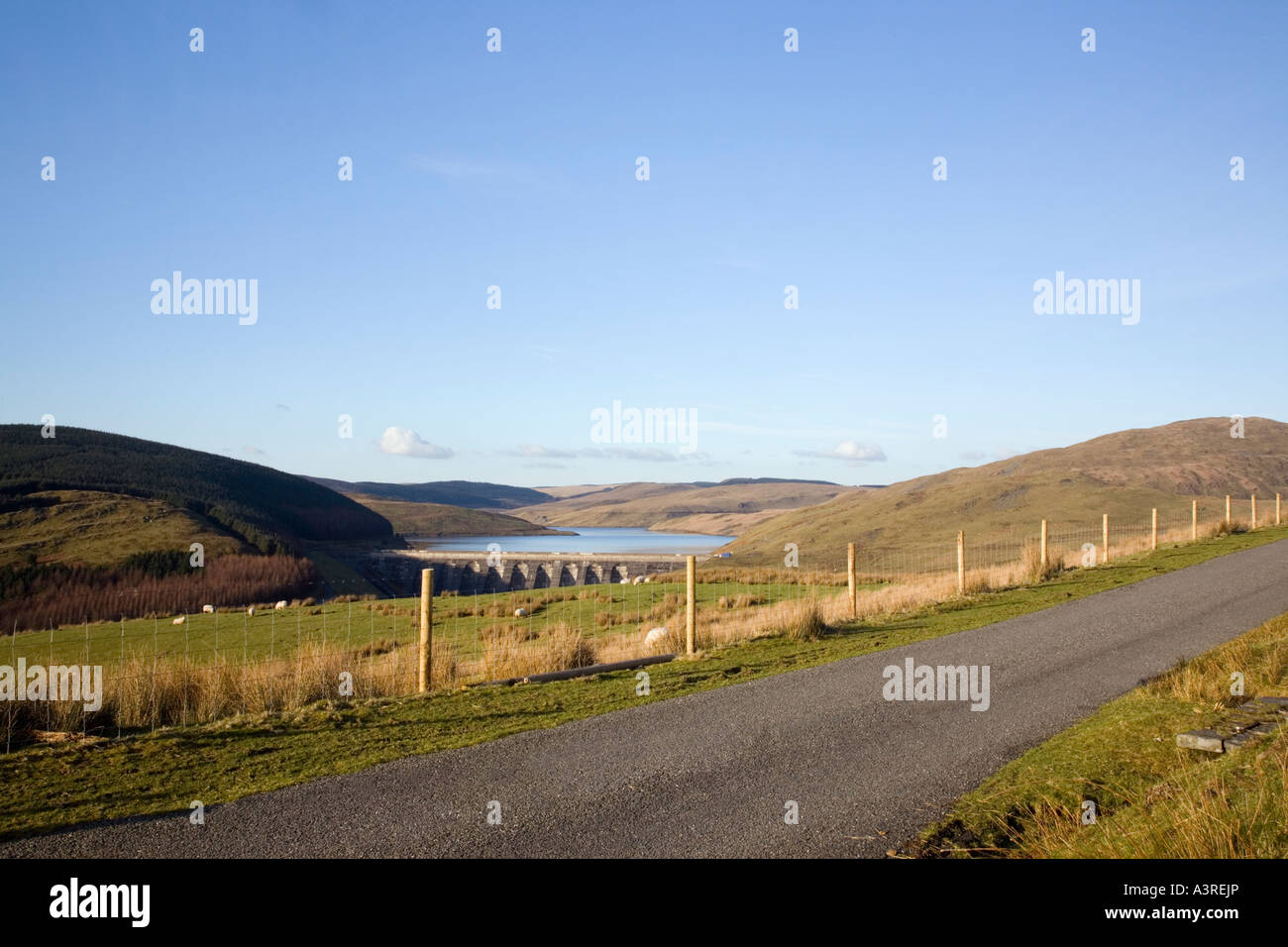 Scenic rural view of Llyn Nant y moch reservoir and dam from minor road ...