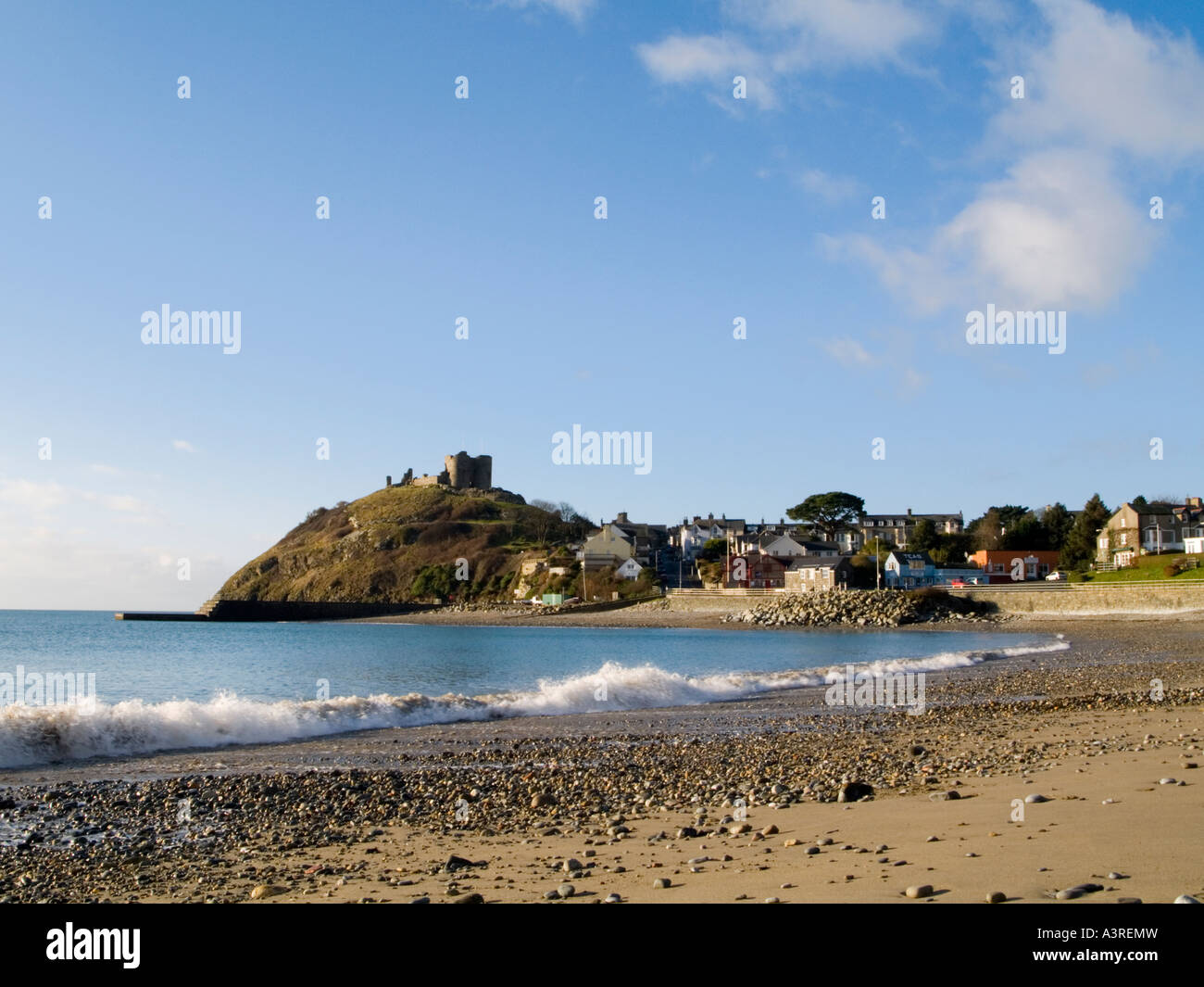 13th Century Castle on rocky headland from east beach in Cardigan bay ...