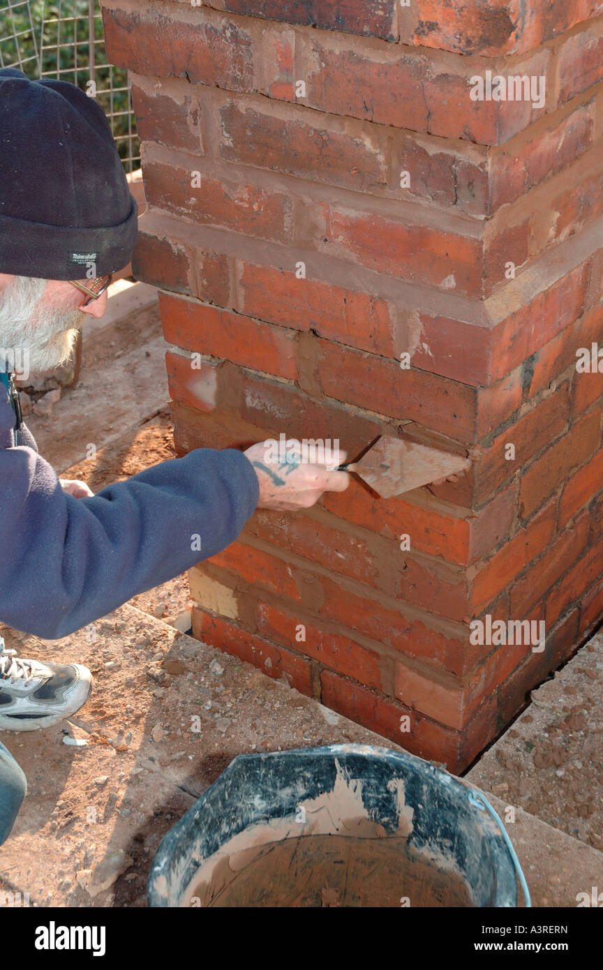 Bricklayer repointing chimney, UK Stock Photo - Alamy