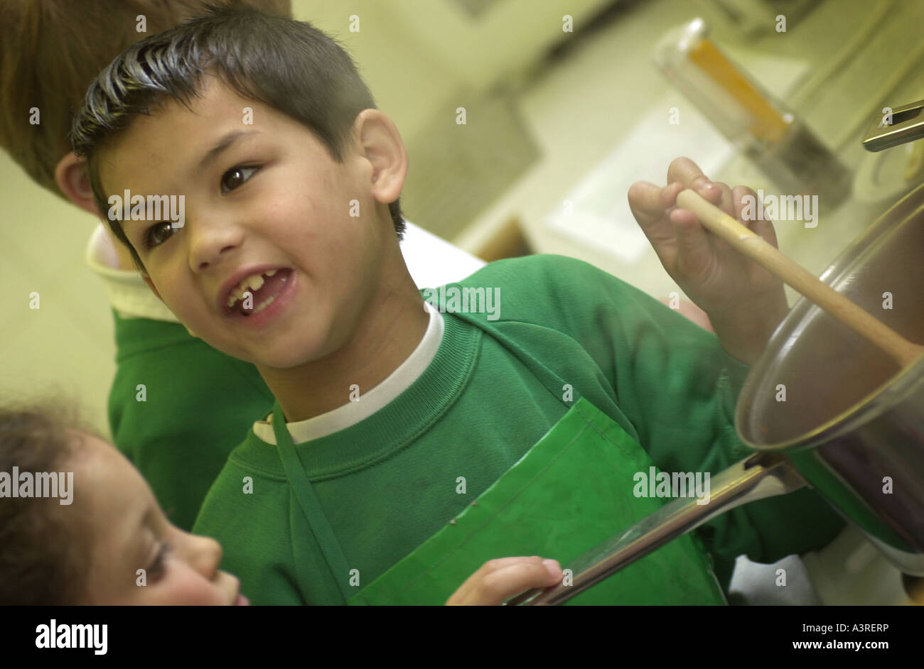 Young boy stirs a sauce in a cookery lesson UK Stock Photo - Alamy