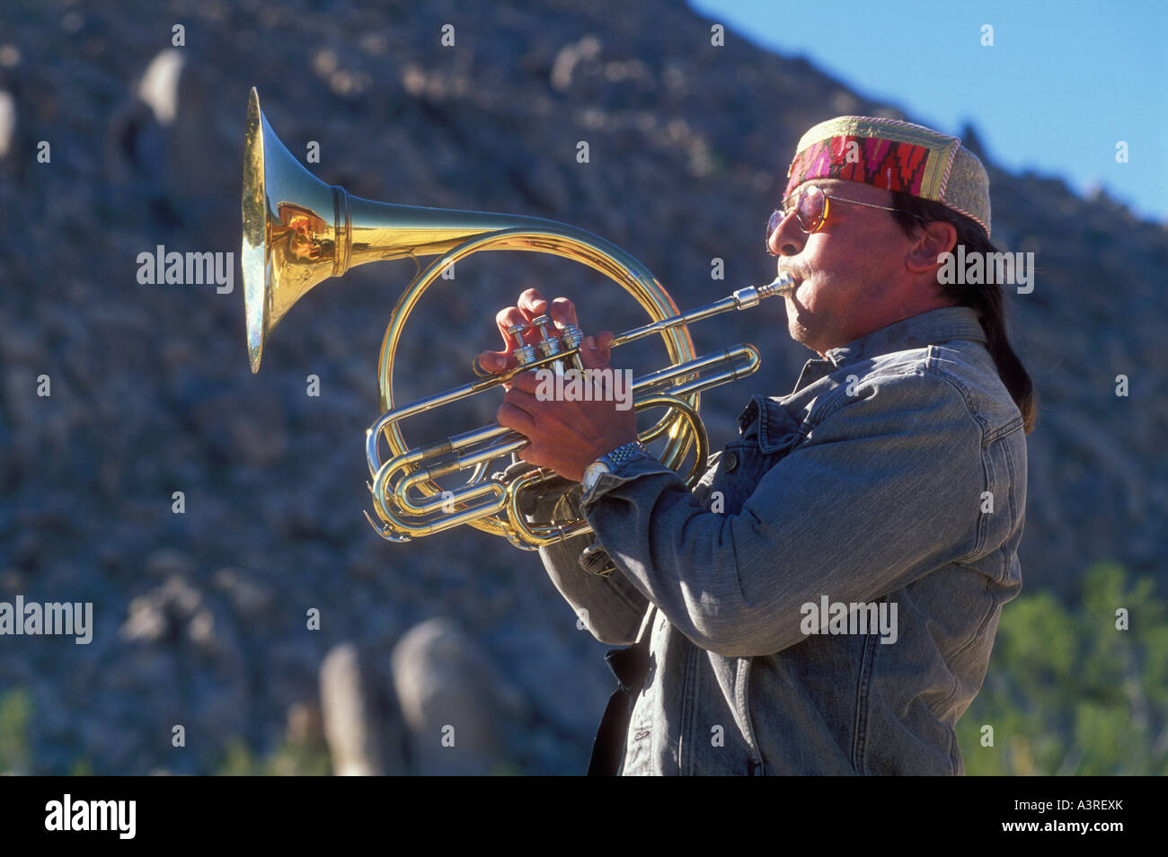 Desert musician playing brass instrument, California Stock Photo - Alamy