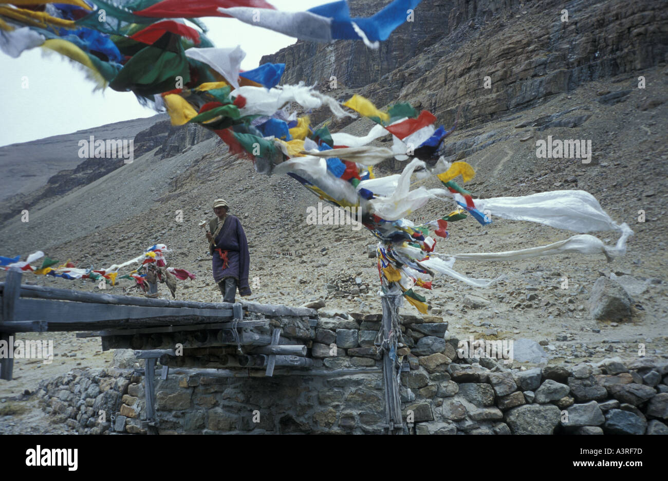 A pilgrim on the circuit of Mt Kailash holy mountain in Tibet Stock ...