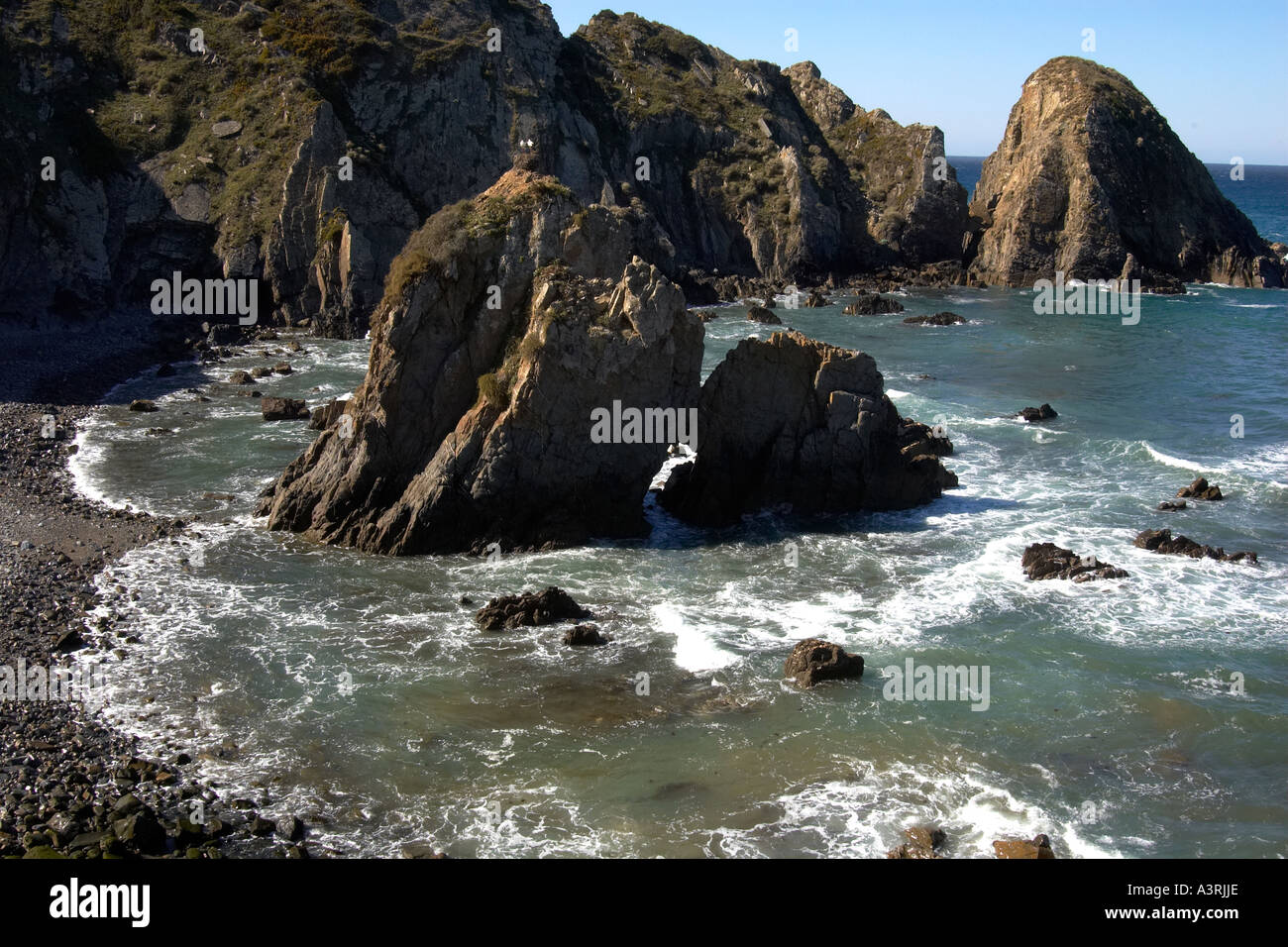 The ebb and flow of the Atlantic washing the shingly beach at Azenha ...