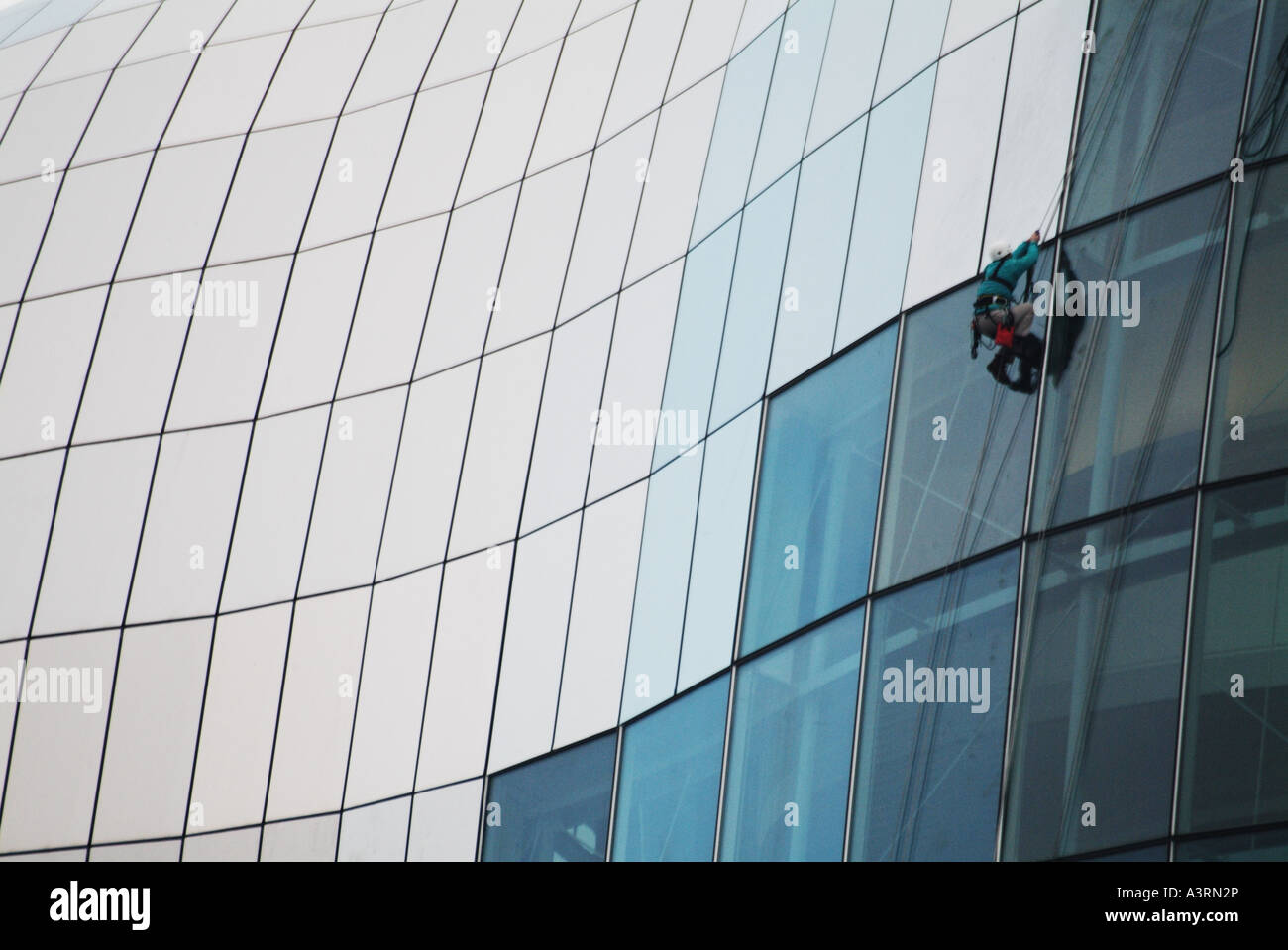 Workman on the side of the Gateshead Sage music centre Stock Photo - Alamy