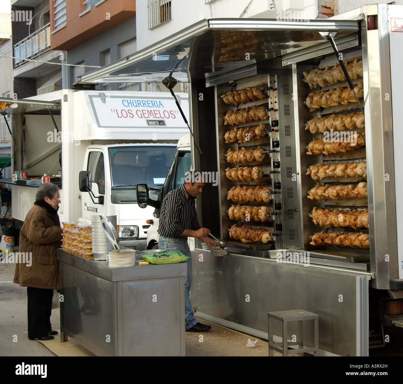 Vendor selling cooked chicken from a van at Garrucha market in ...