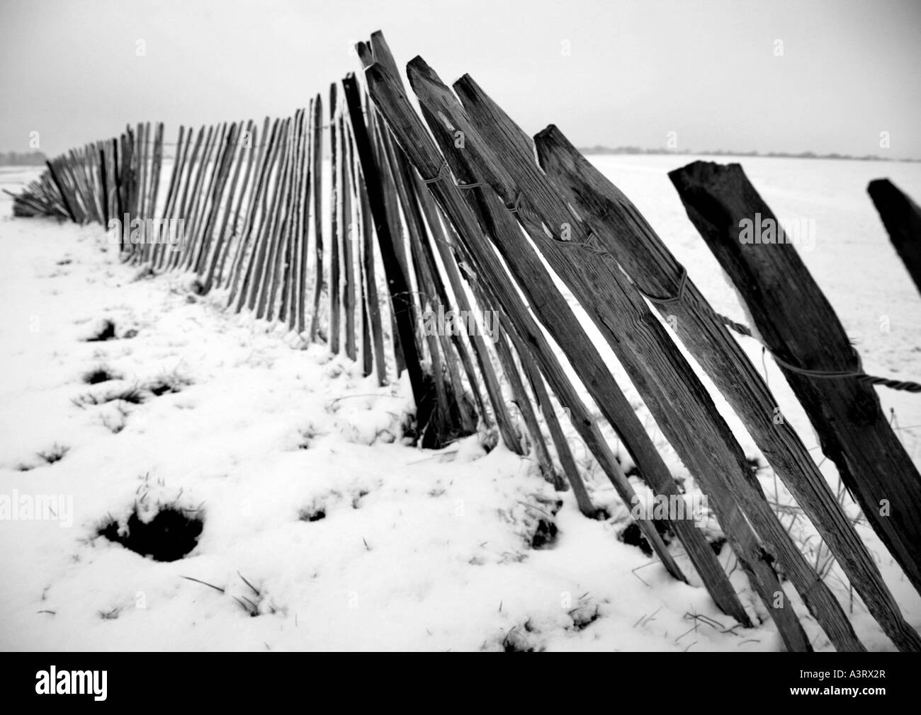 broken fence in wintry scene Stock Photo - Alamy