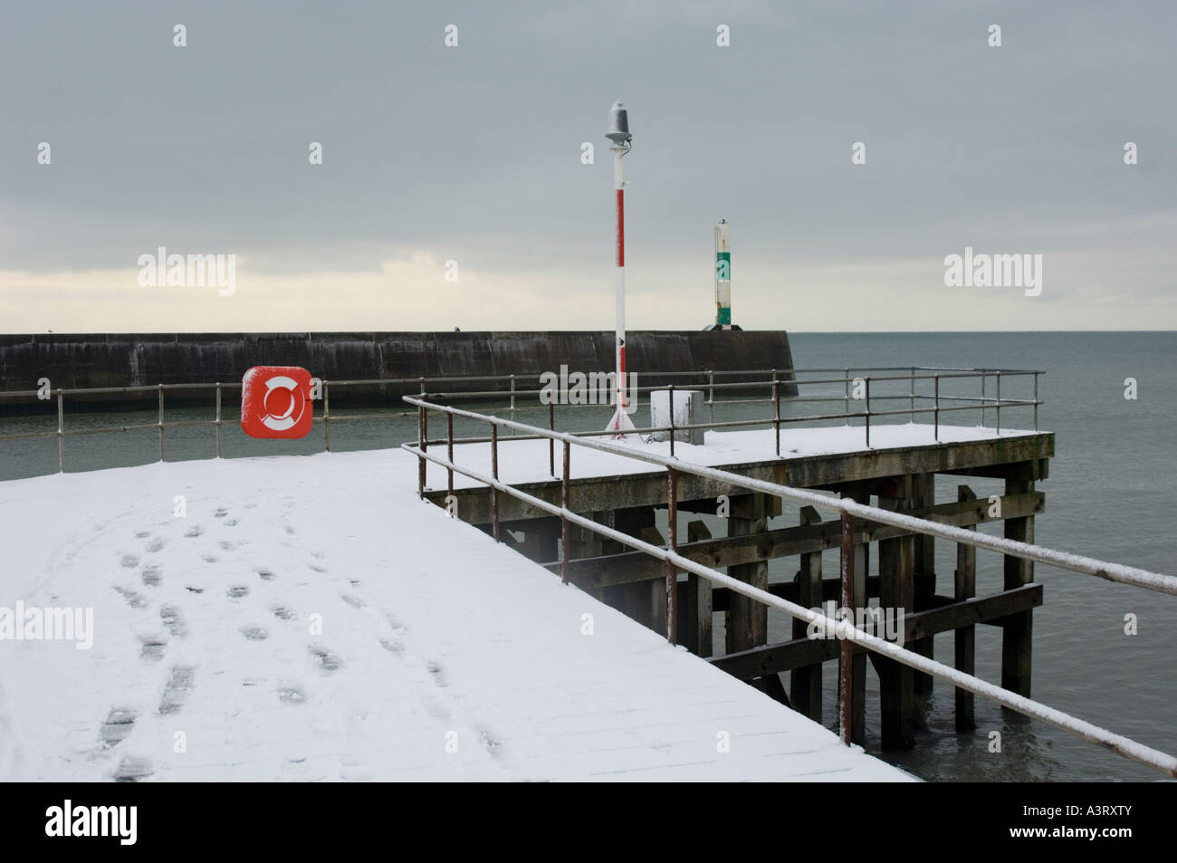 The entrance to Aberystwyth harbour in the snow, winter afternoon ...