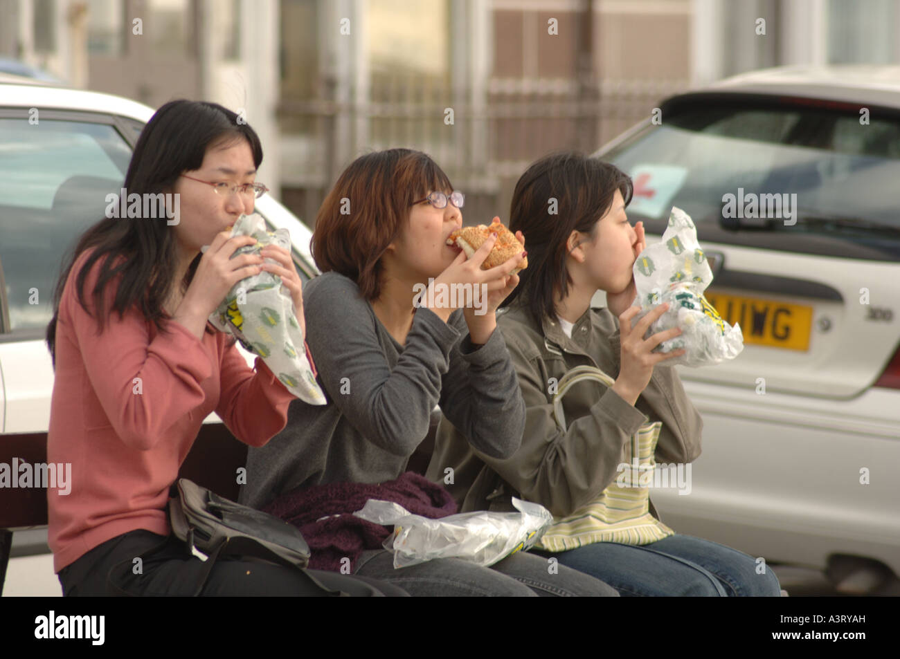 aberystwyth promenade three chinese women students eating fast food ...