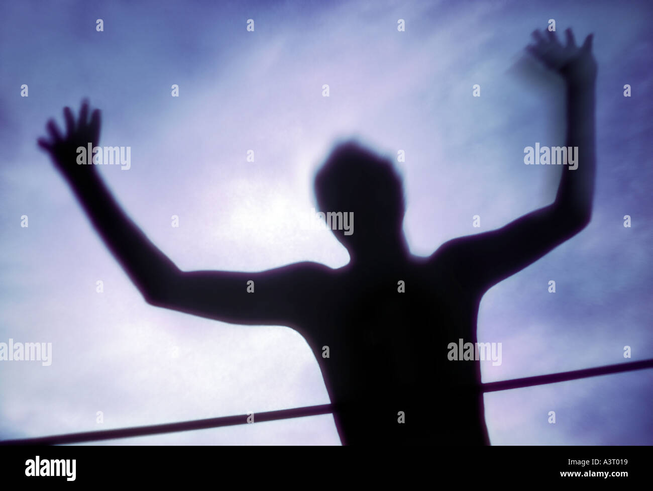 Running athlete crossing finishing race tape Stock Photo - Alamy