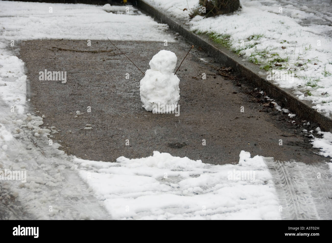 small snowman in snow free parking space Stock Photo - Alamy