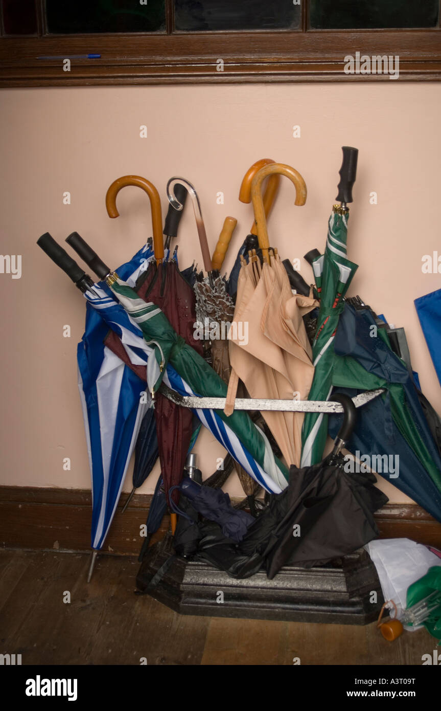 Umbrellas in rack in the porch of a church chapel in wales on a wet ...