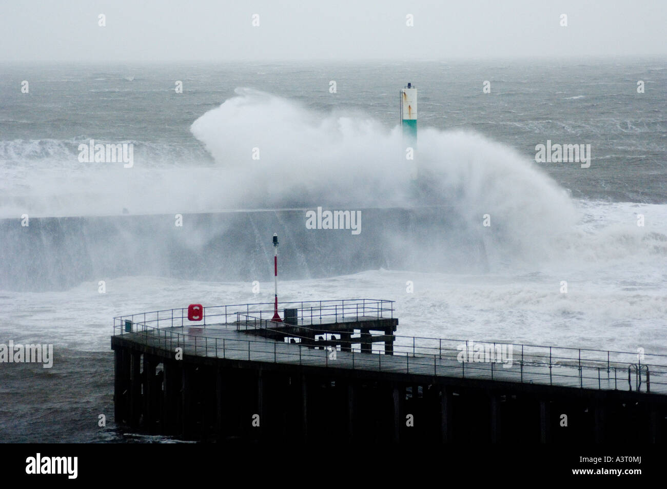 High gale force winds and waves battering the harbour wall during ...