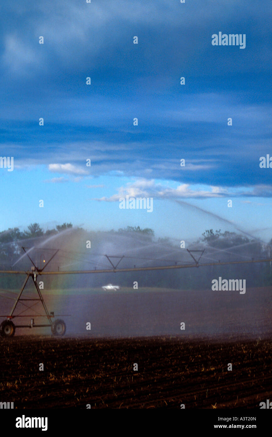 A RAINBOW IS SEEN IN THE WATERS OF AN IRRIGATION SYSTEM IN CENTRAL ...