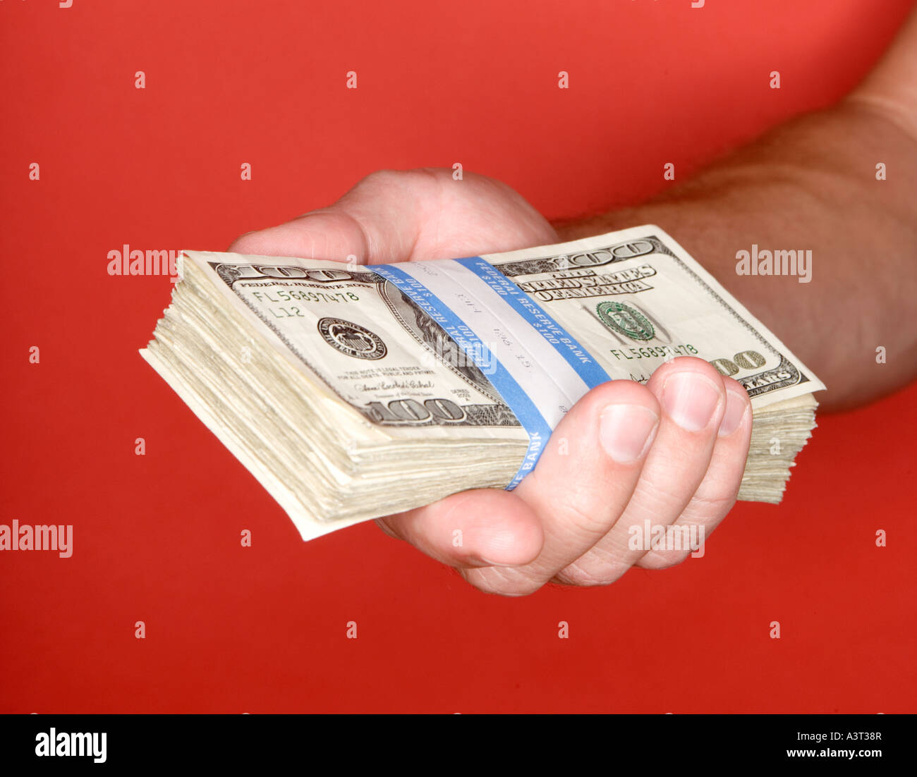 Man's hand holding a wad of money Stock Photo - Alamy
